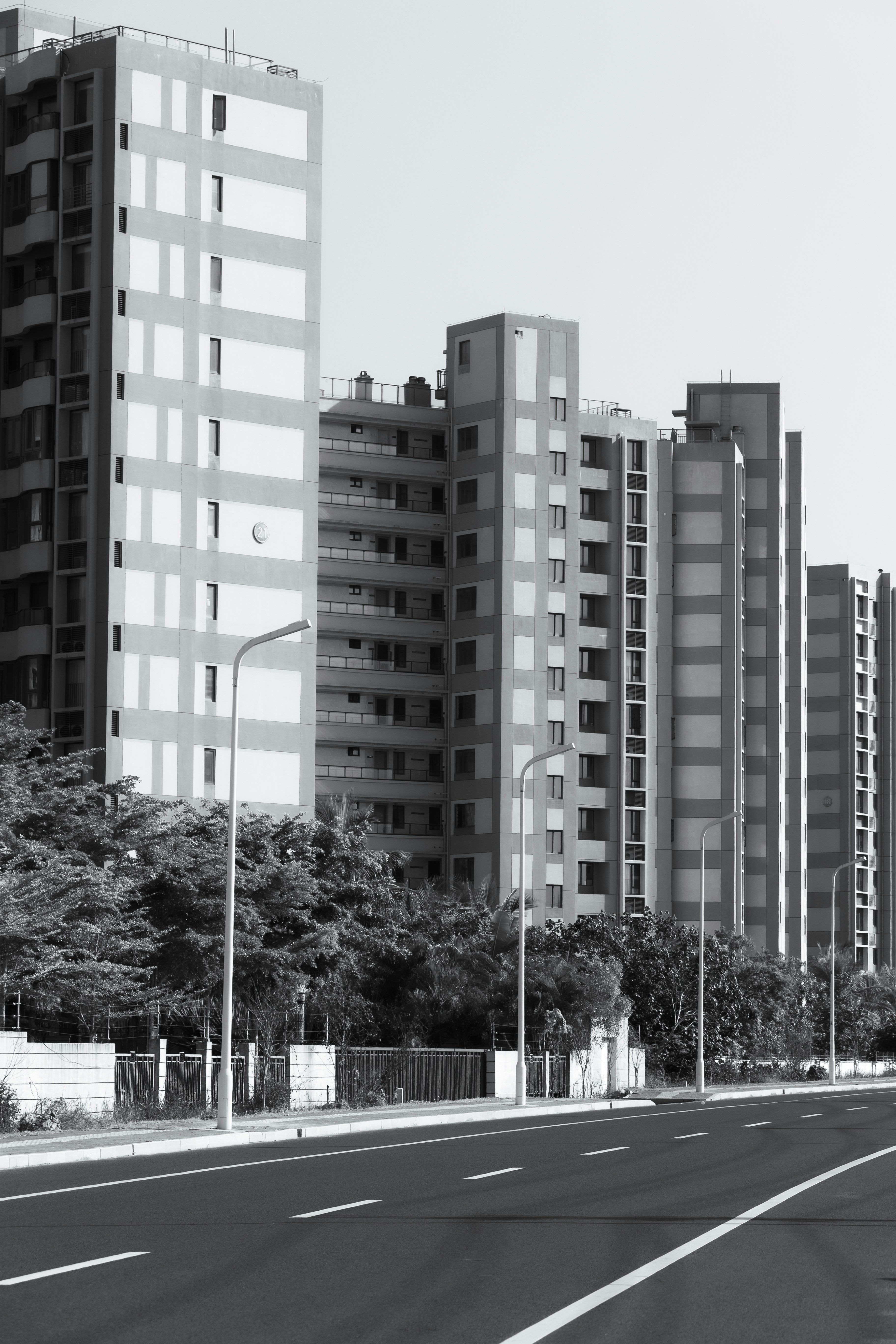 Monochrome City Edge: Towers Rising Over a Quiet Street
