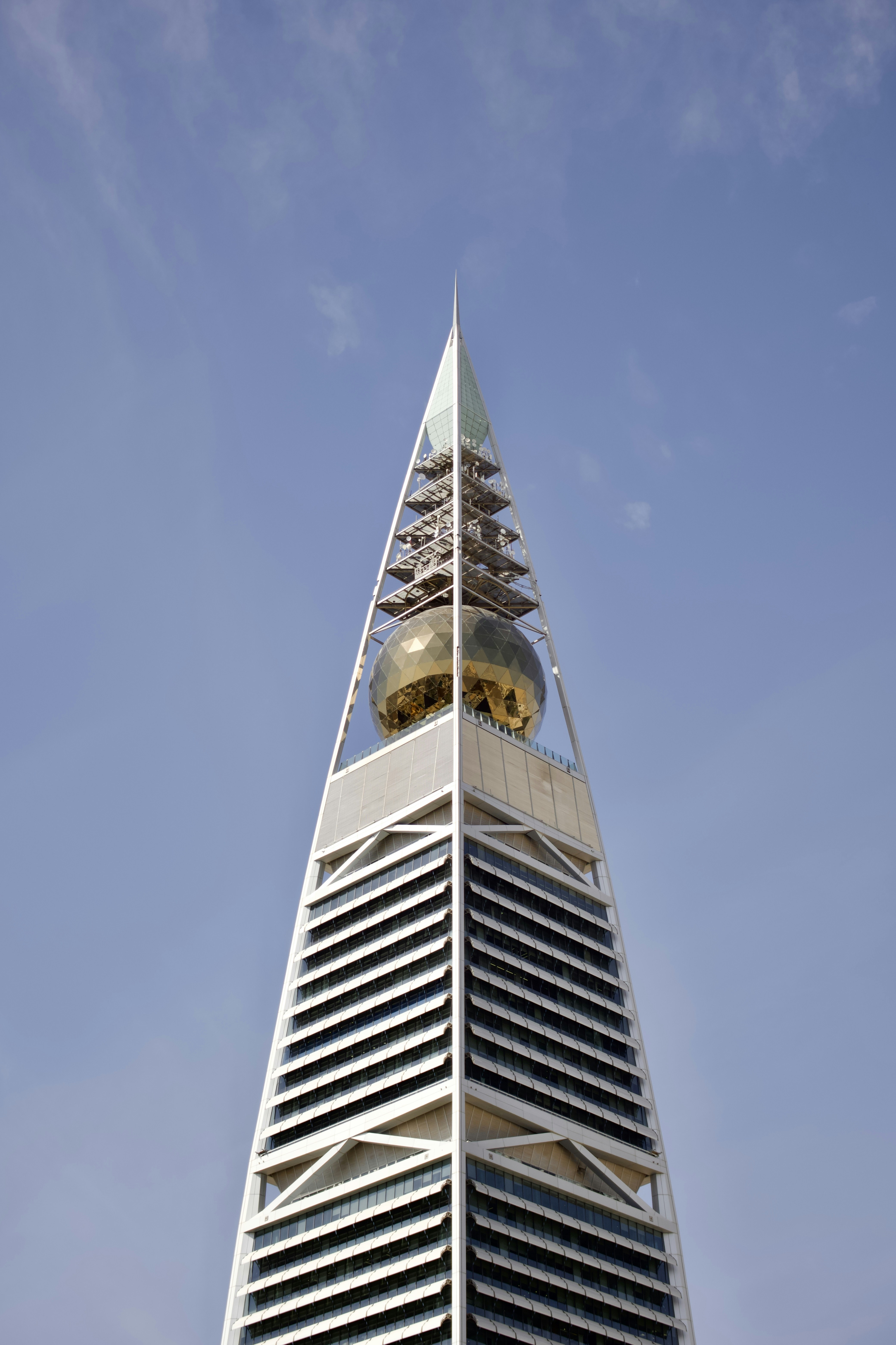 Spire in the Sky: The Golden Sphere Against a Clear Blue