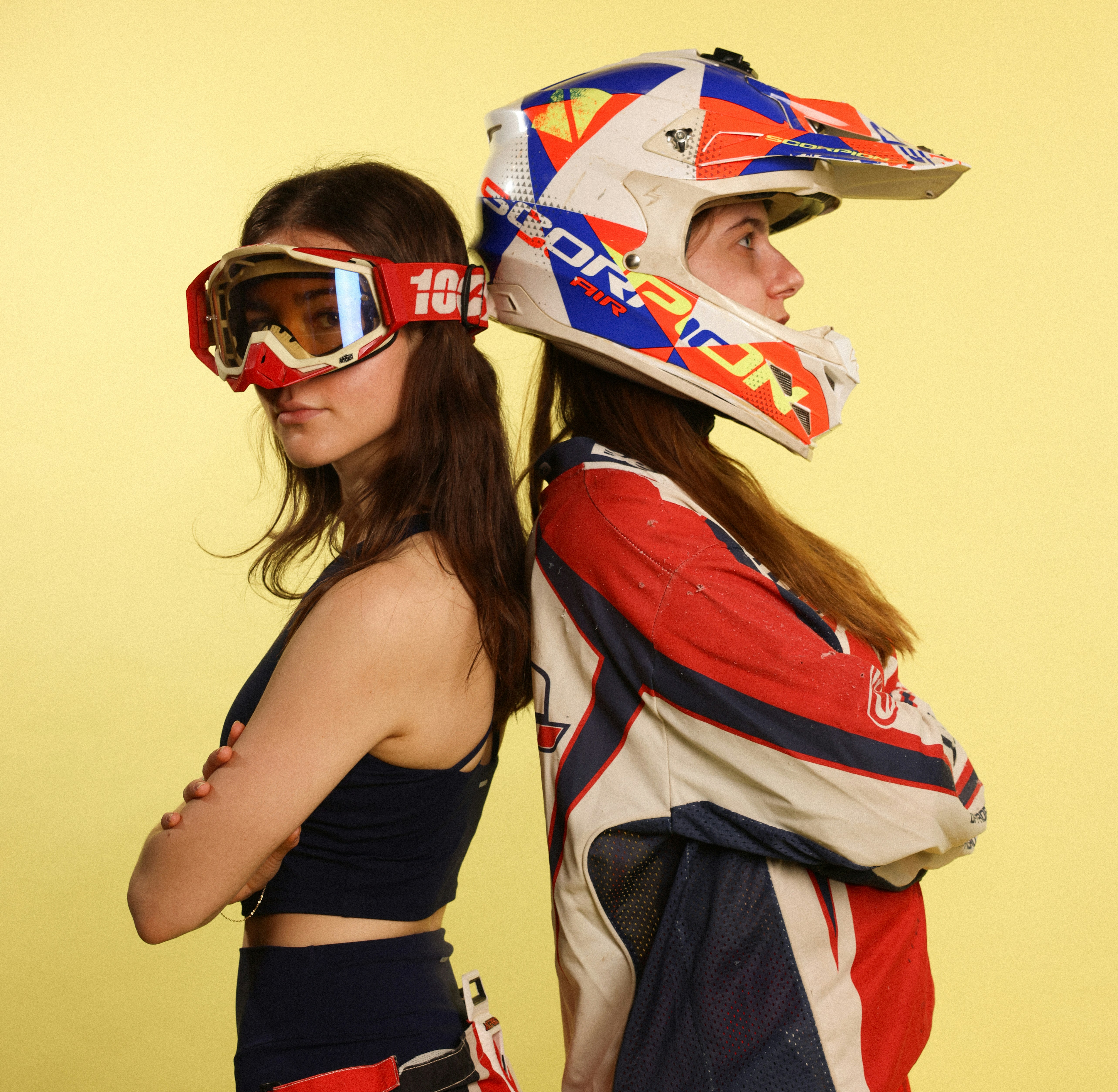 Two Riders Back-to-Back: Masked Confidence in a Bright Studio