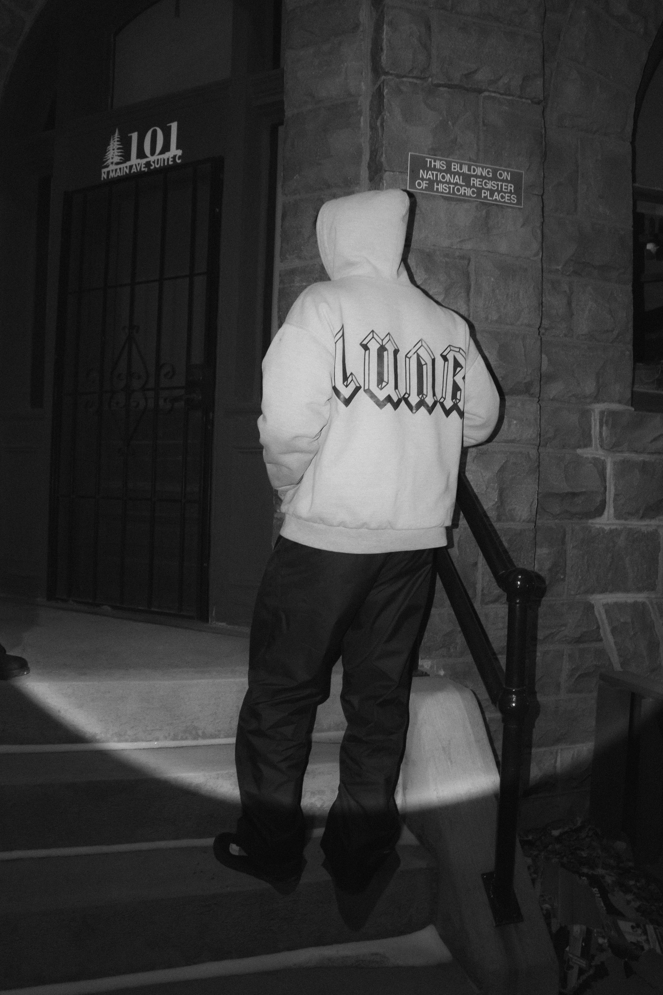 Midnight Stairs: A Hoodie Silhouette by the Gate