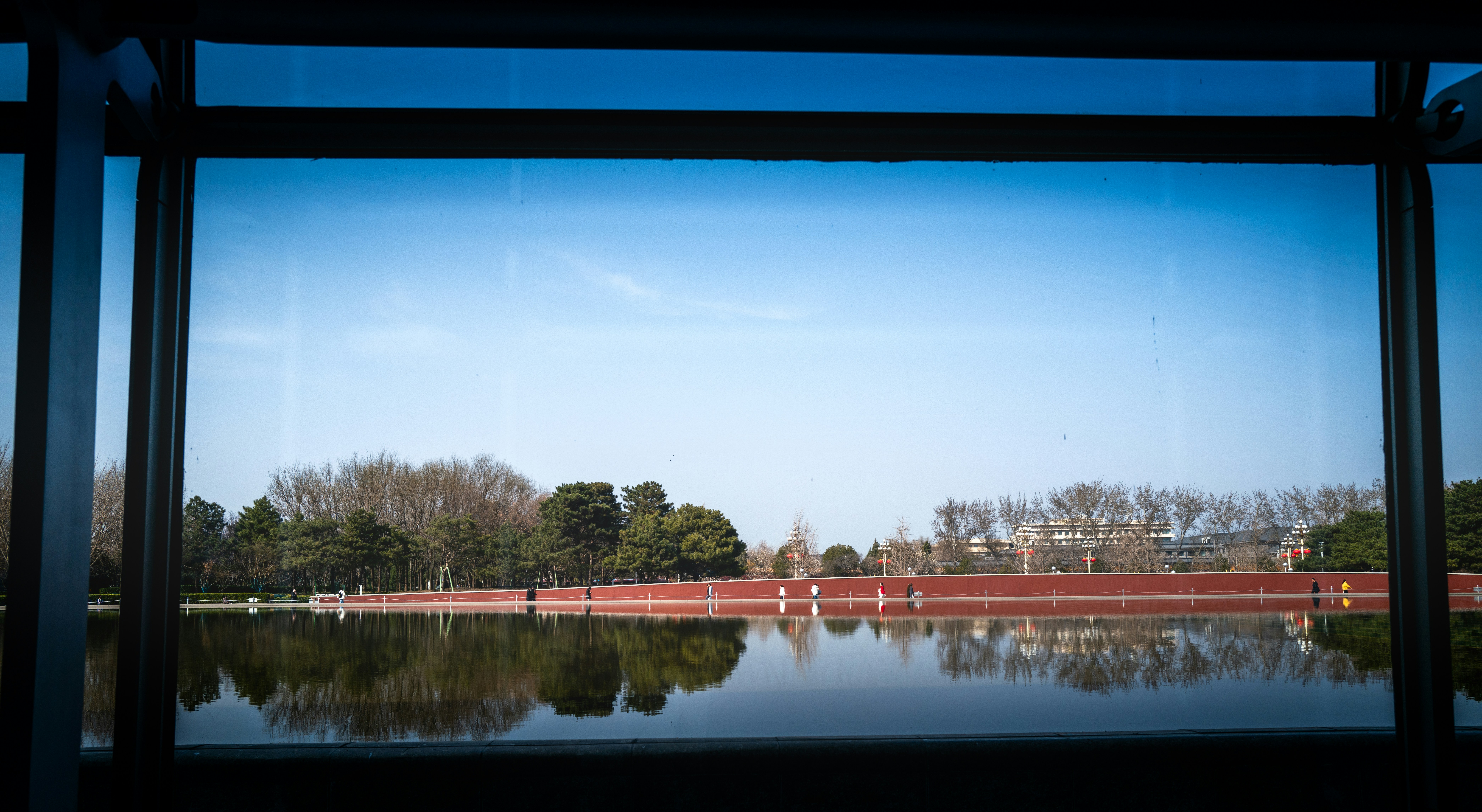 Symmetry at the Window: A Quiet Lake Framed by Steel and Glass