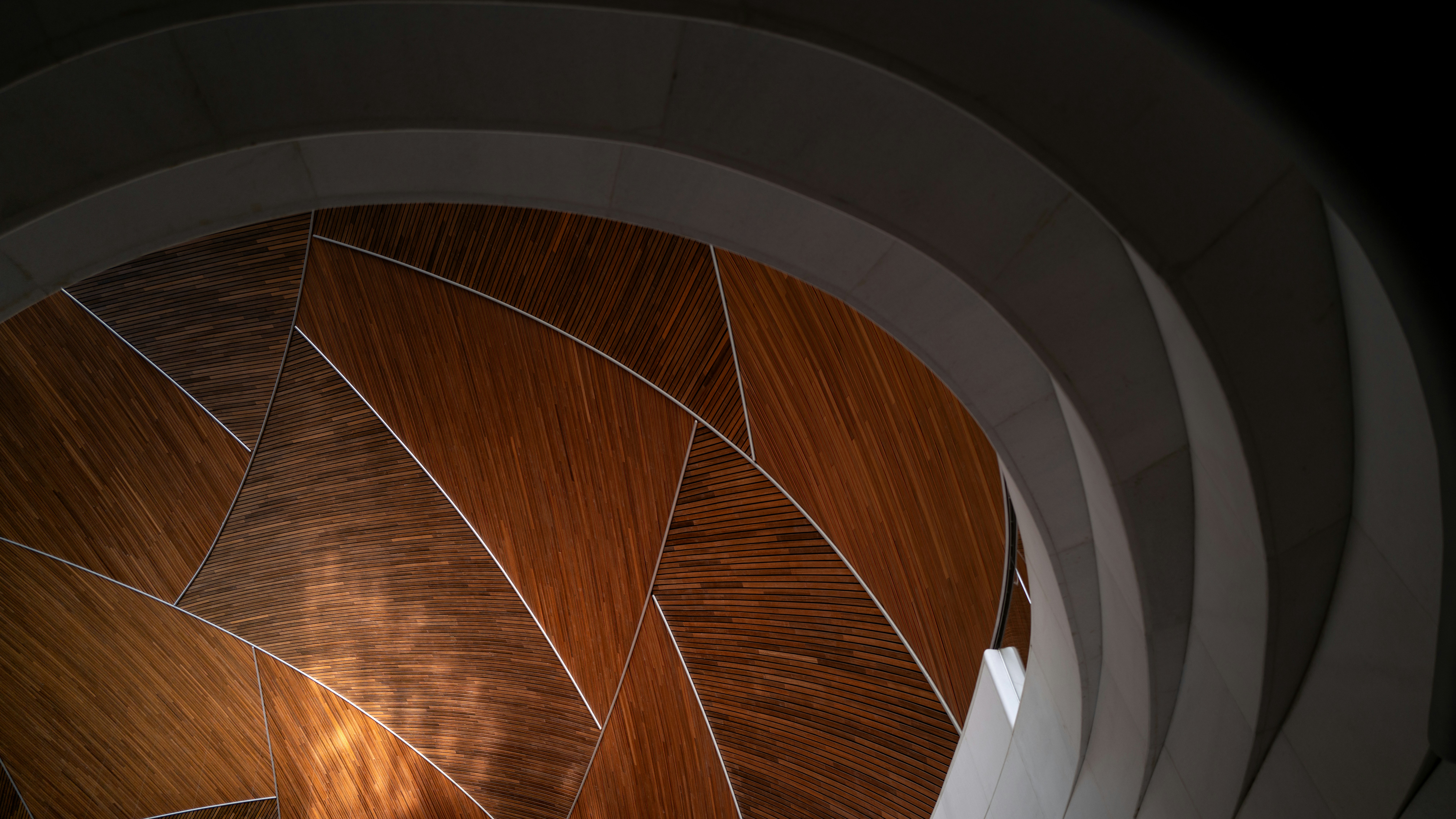 Curved Wooden Spiral: Light and Shadow in an Architectural Atrium
