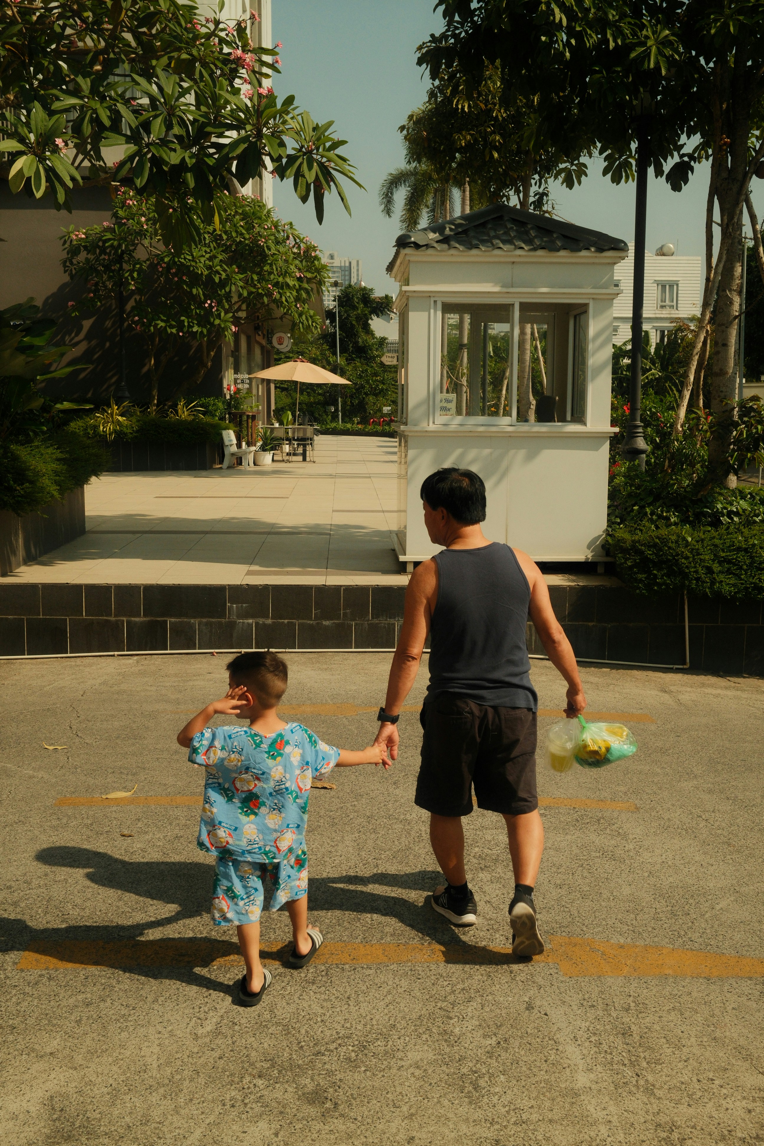 Father and Child Crossing the Quiet Path