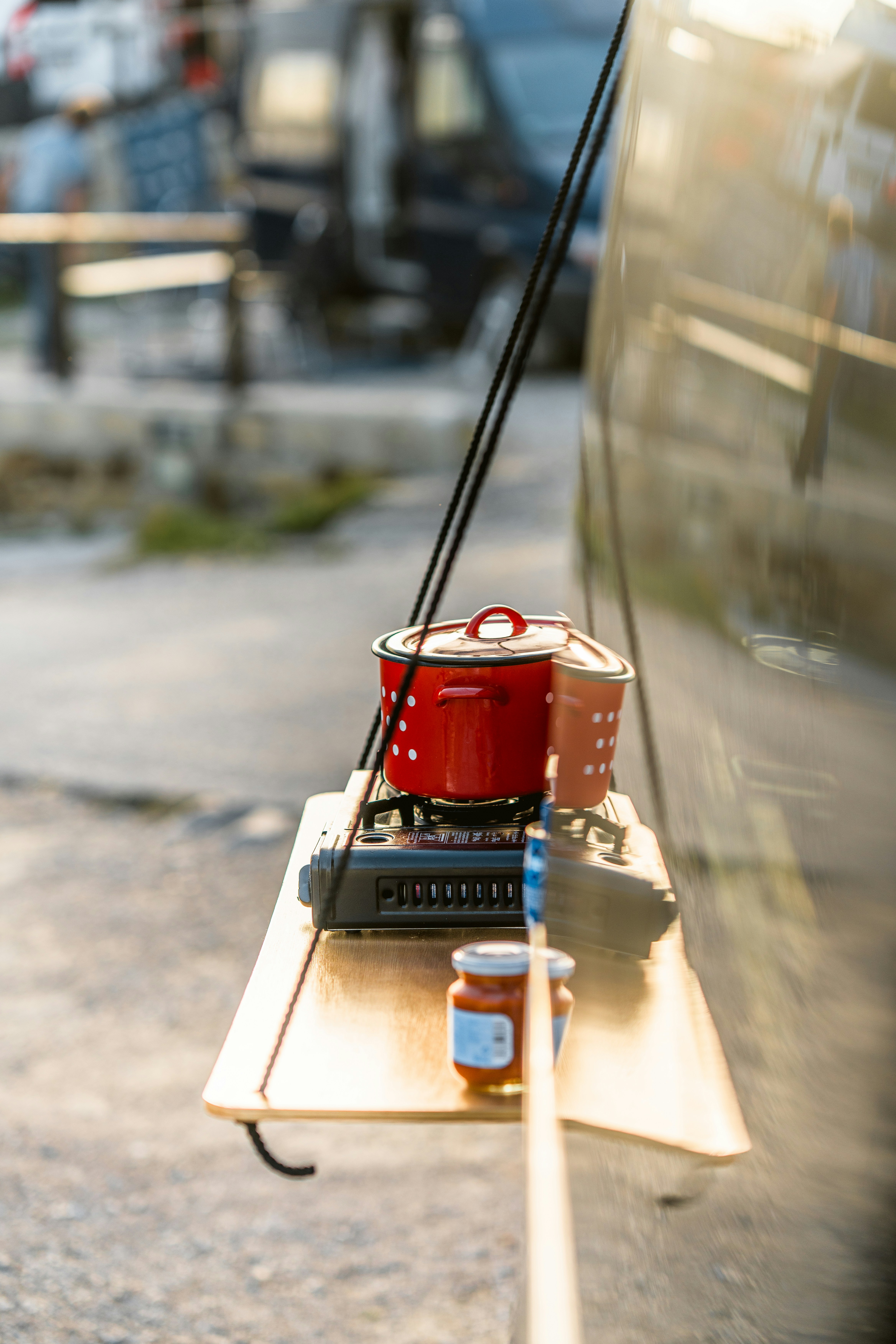 Campfire on a Railing: A Cozy Boat-side Setup in Soft Daylight
