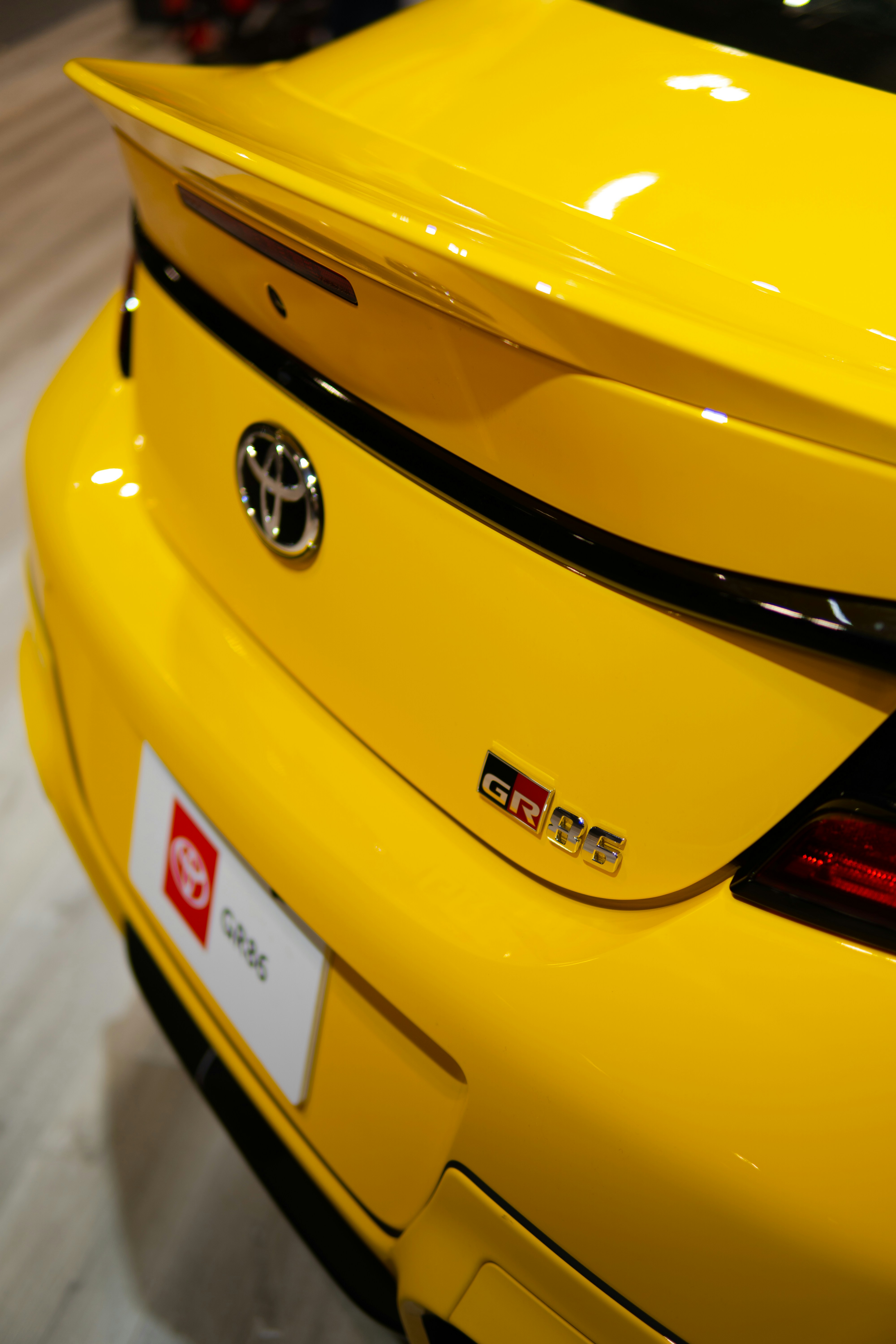 Yellow Toyota GR Yaris Rear Emblem Under Studio Lights