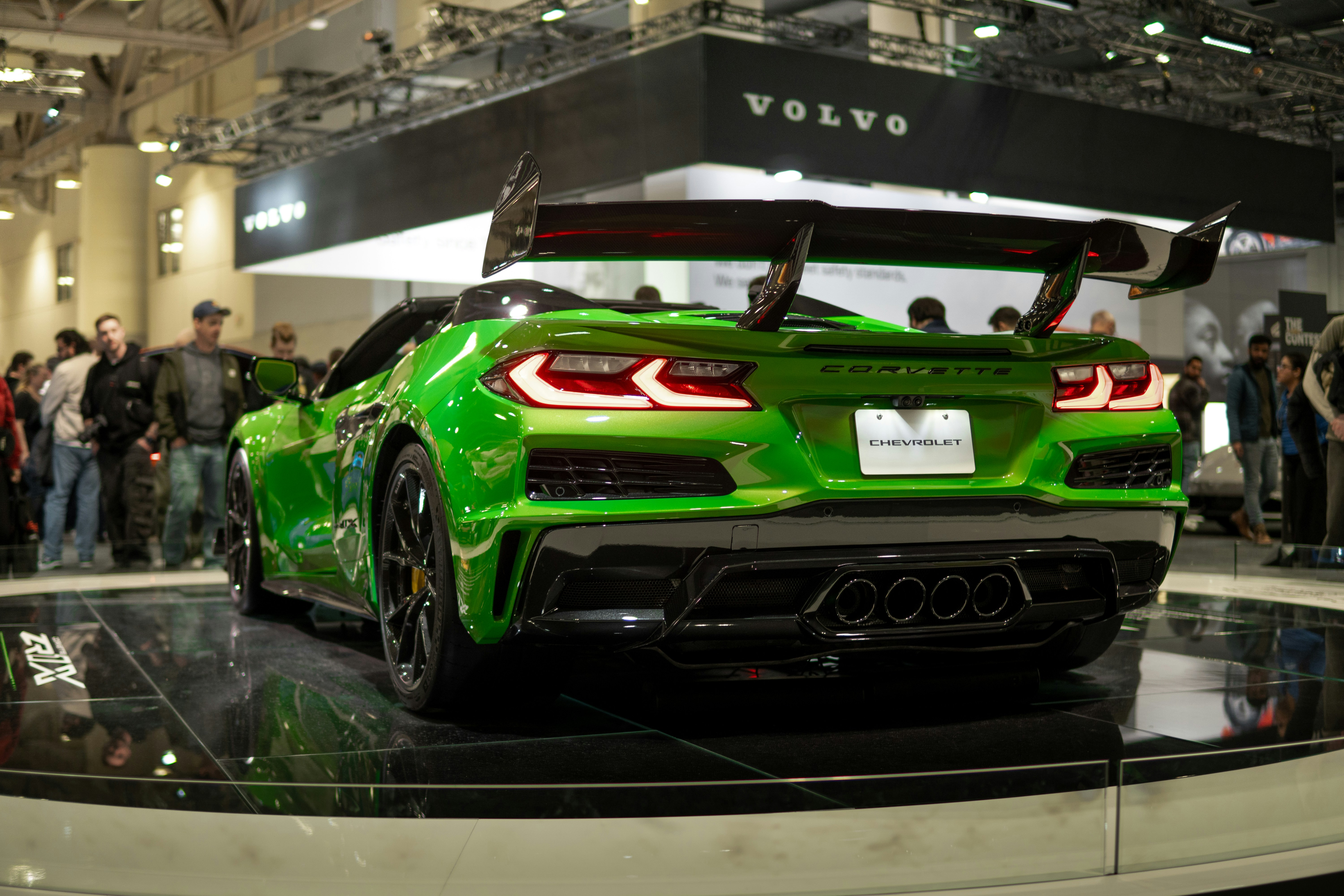 Green Supercar on a Show Floor: Aggressive Rearward Angles
