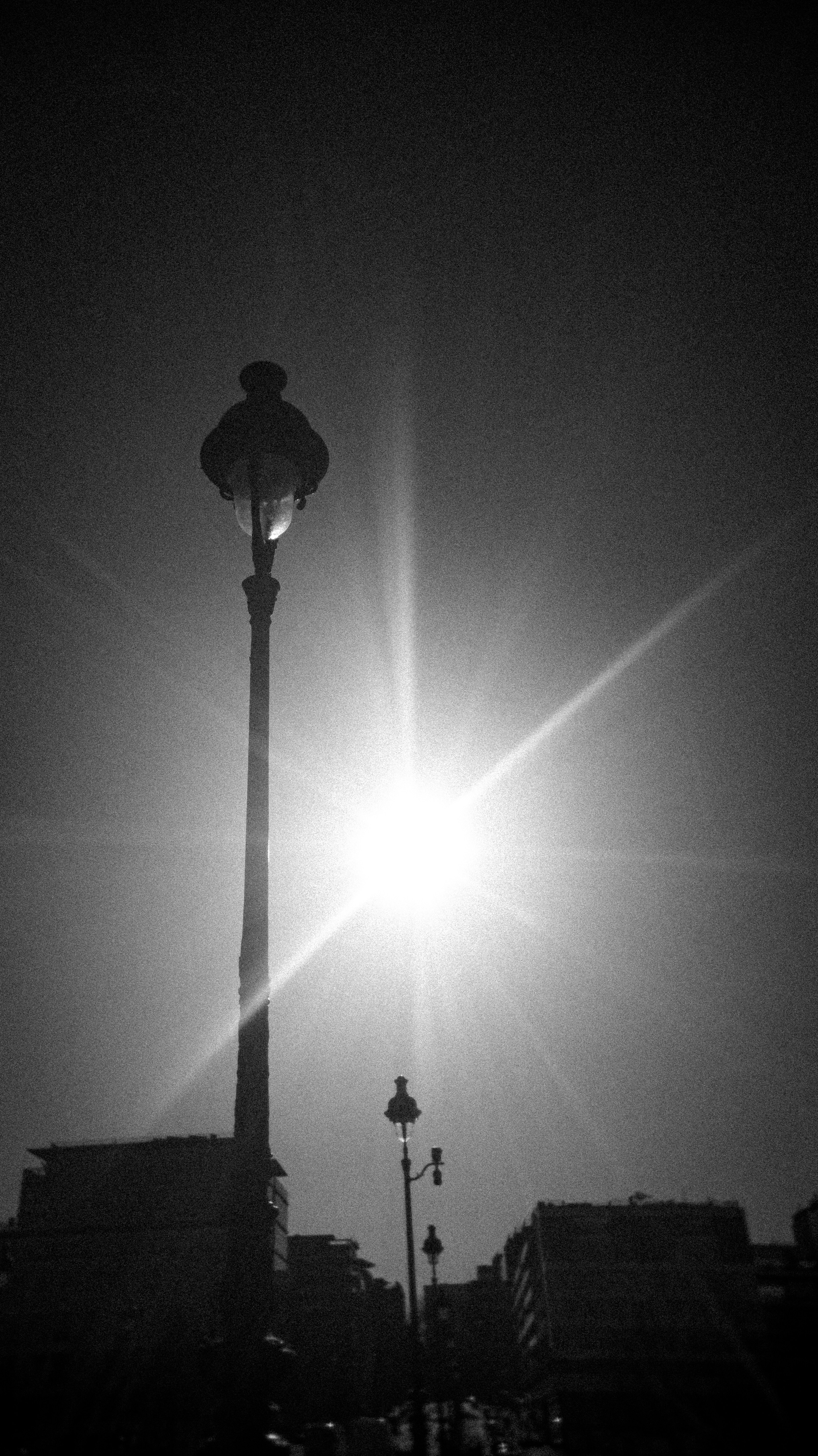 Sunburst over the City: A Night Street Lantern in Mono