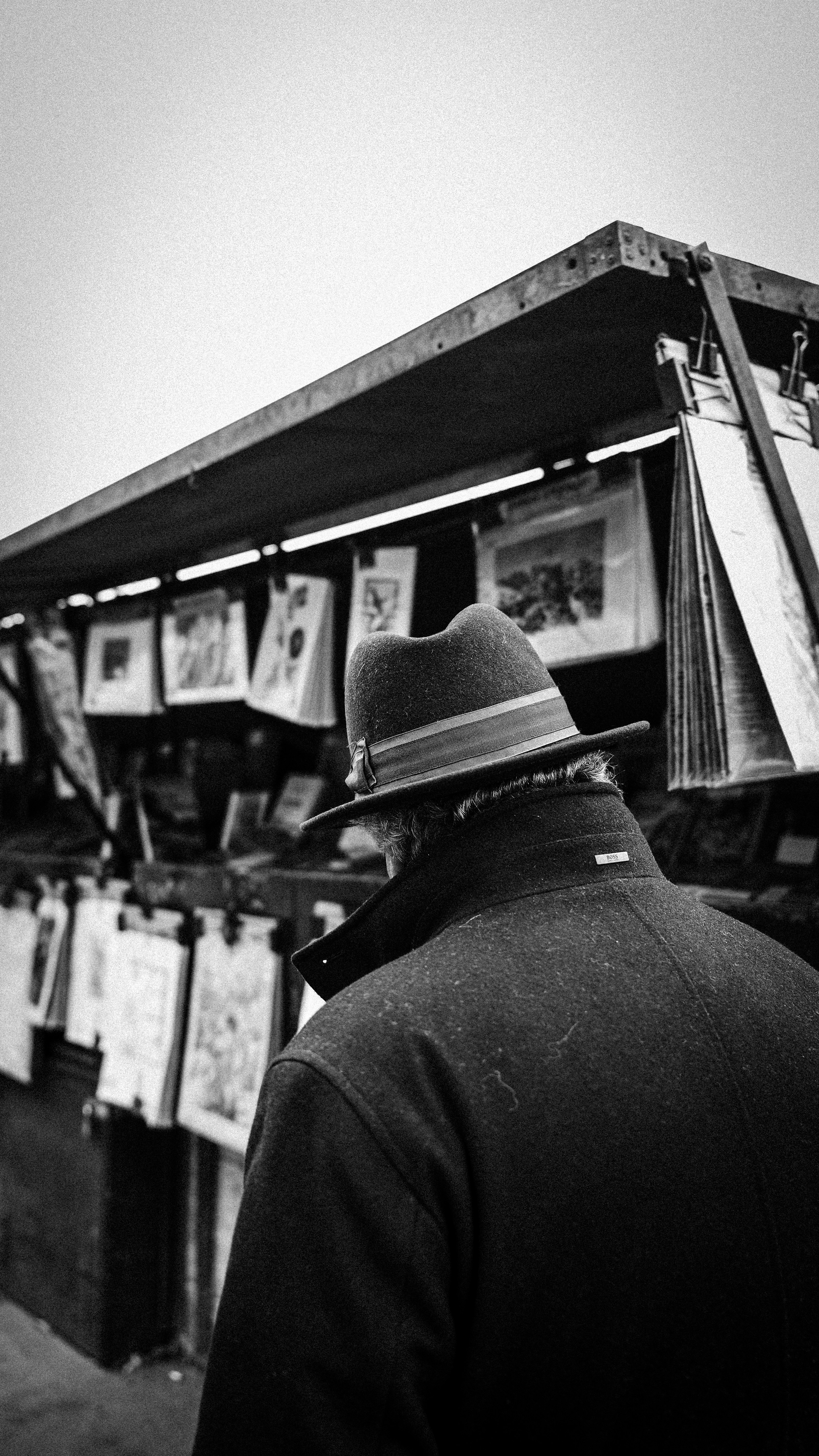 Vendor Under the Slanted Roof: A Quiet Portrait of a Street Painter