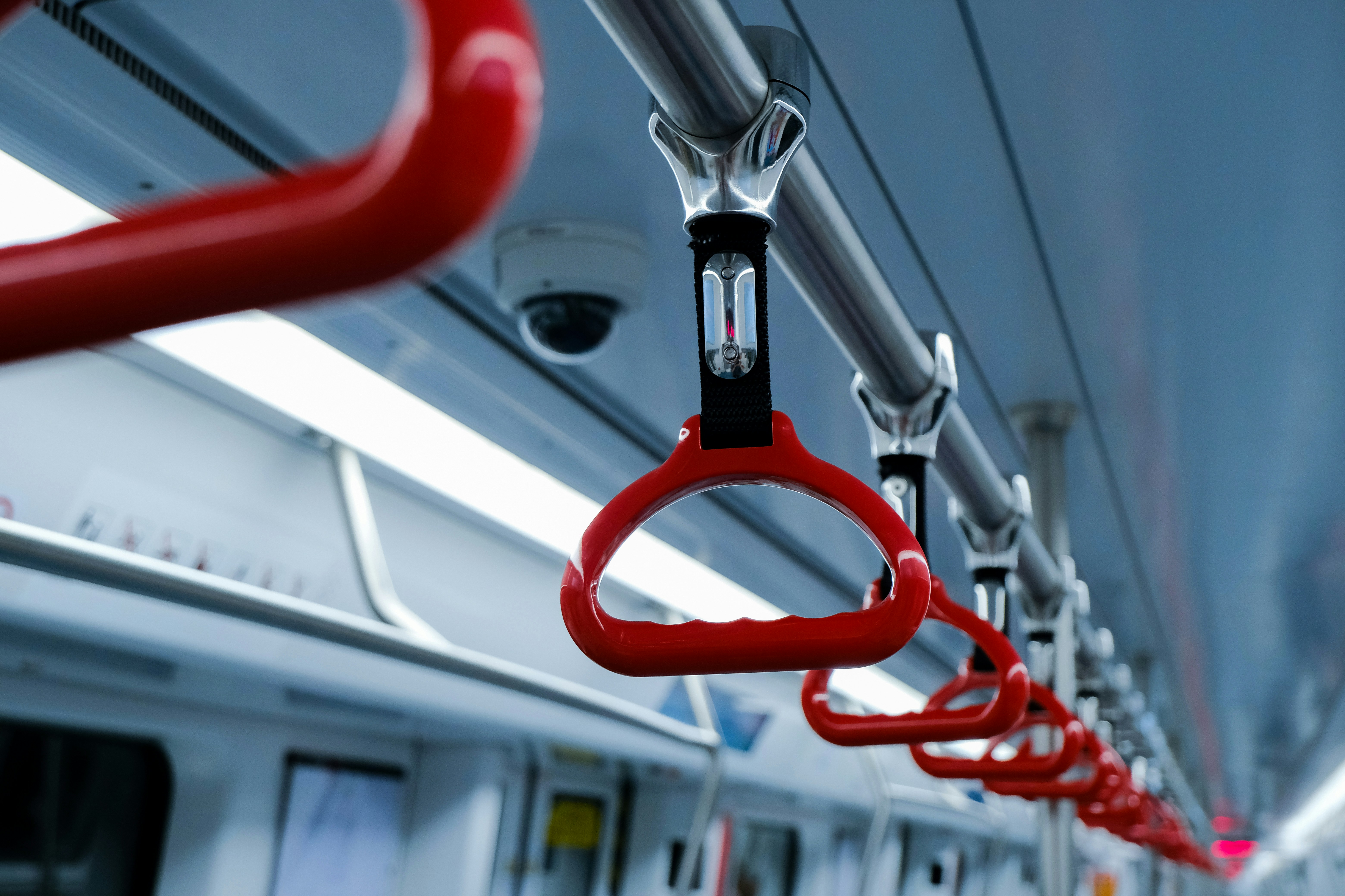 Red Handholds in Aisle: A Quiet Voyage Between Rails