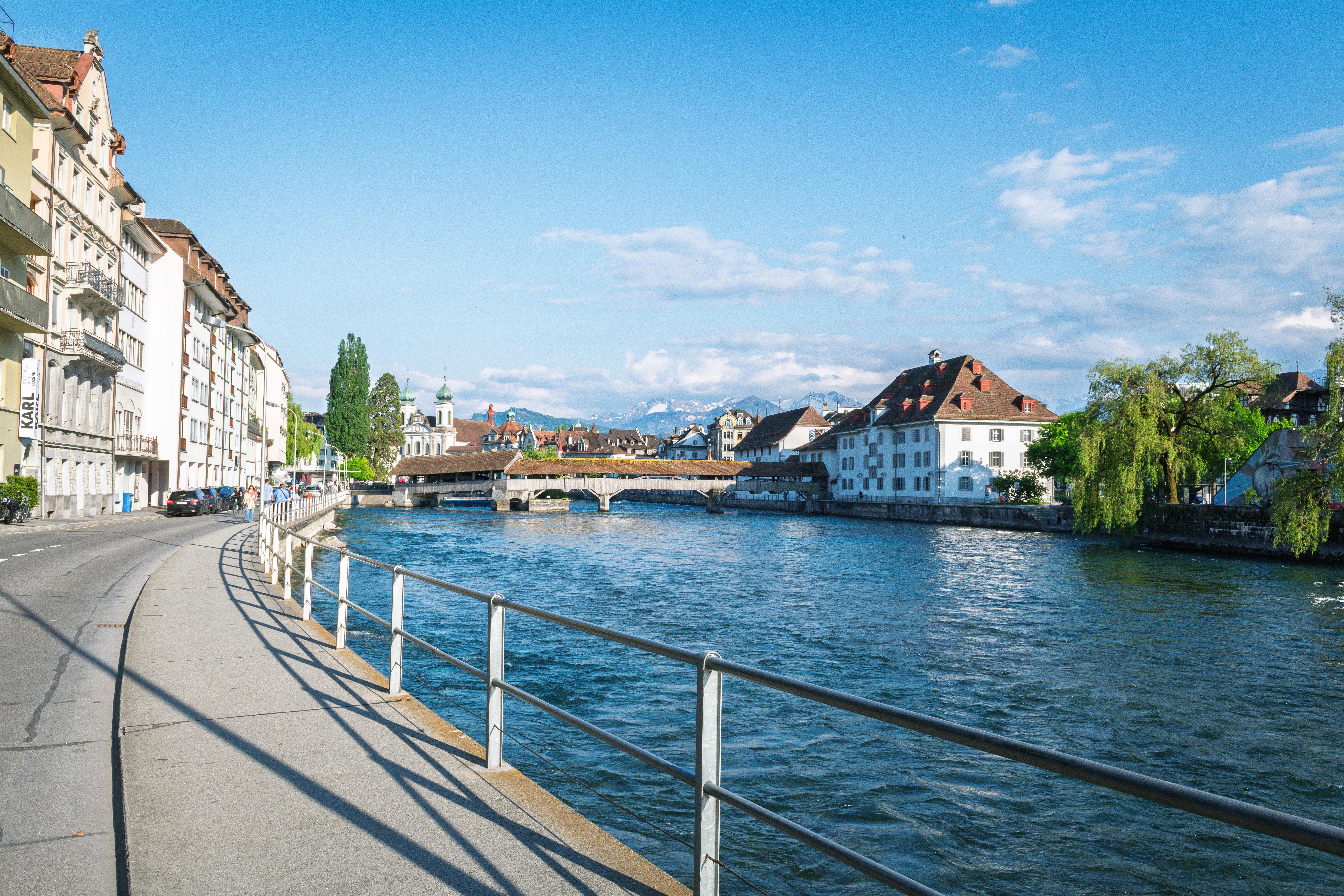 Riverside Arc: A sunlit Promenade Beside the Calm