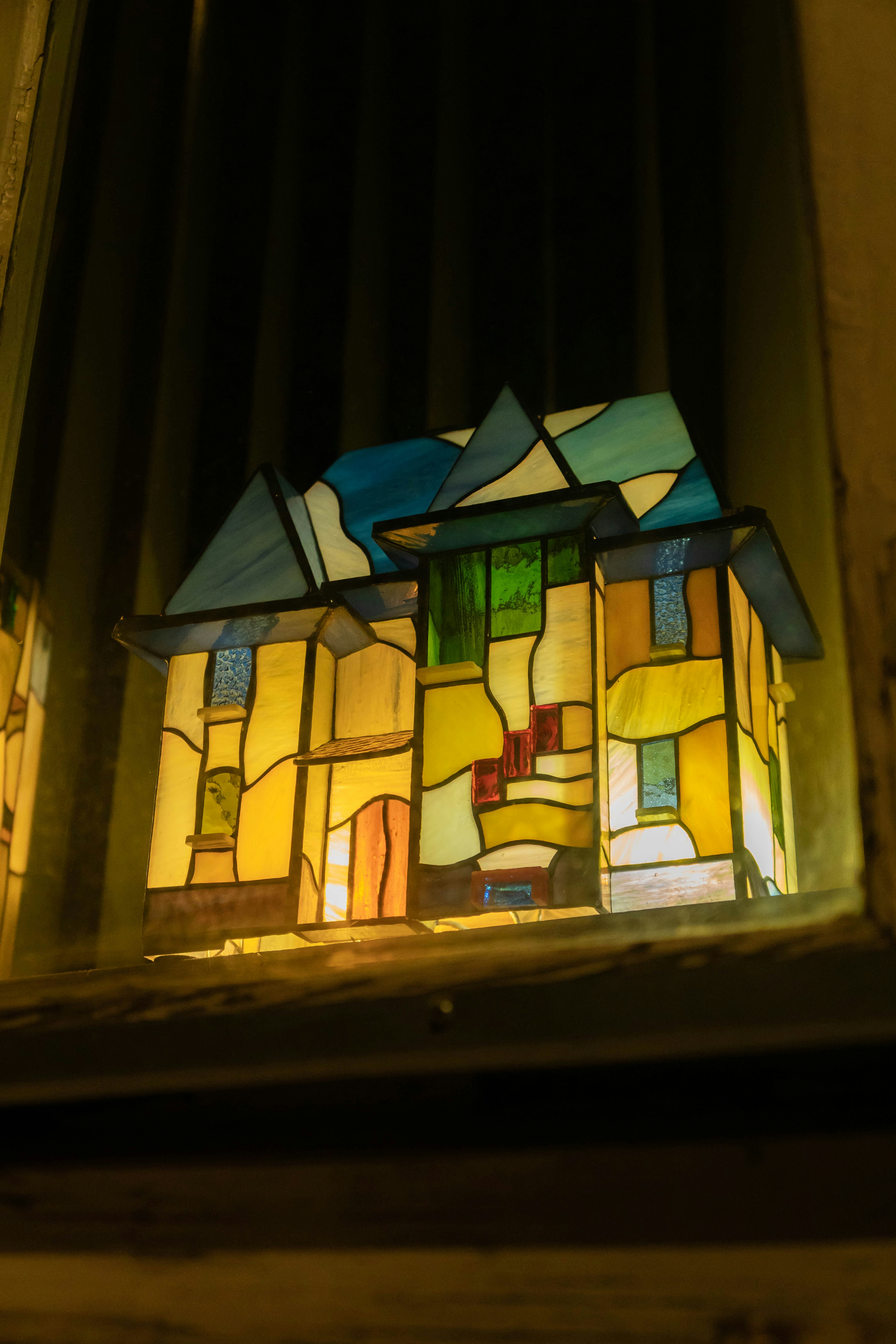 Stained-glass House Glow in a Dim Window