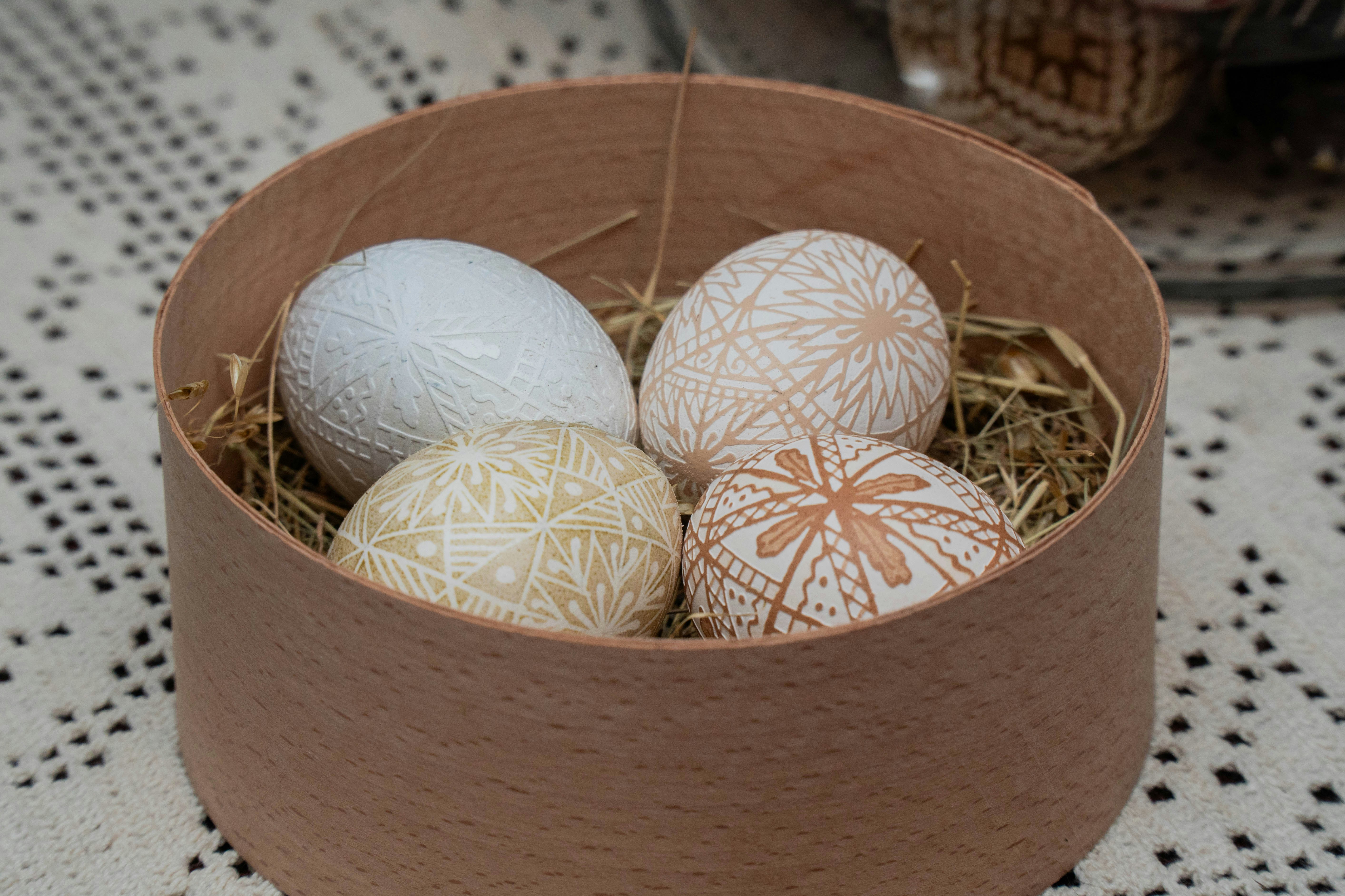 Easter Orbs: Painted Eggs Nestled in a Round Cardboard Basket