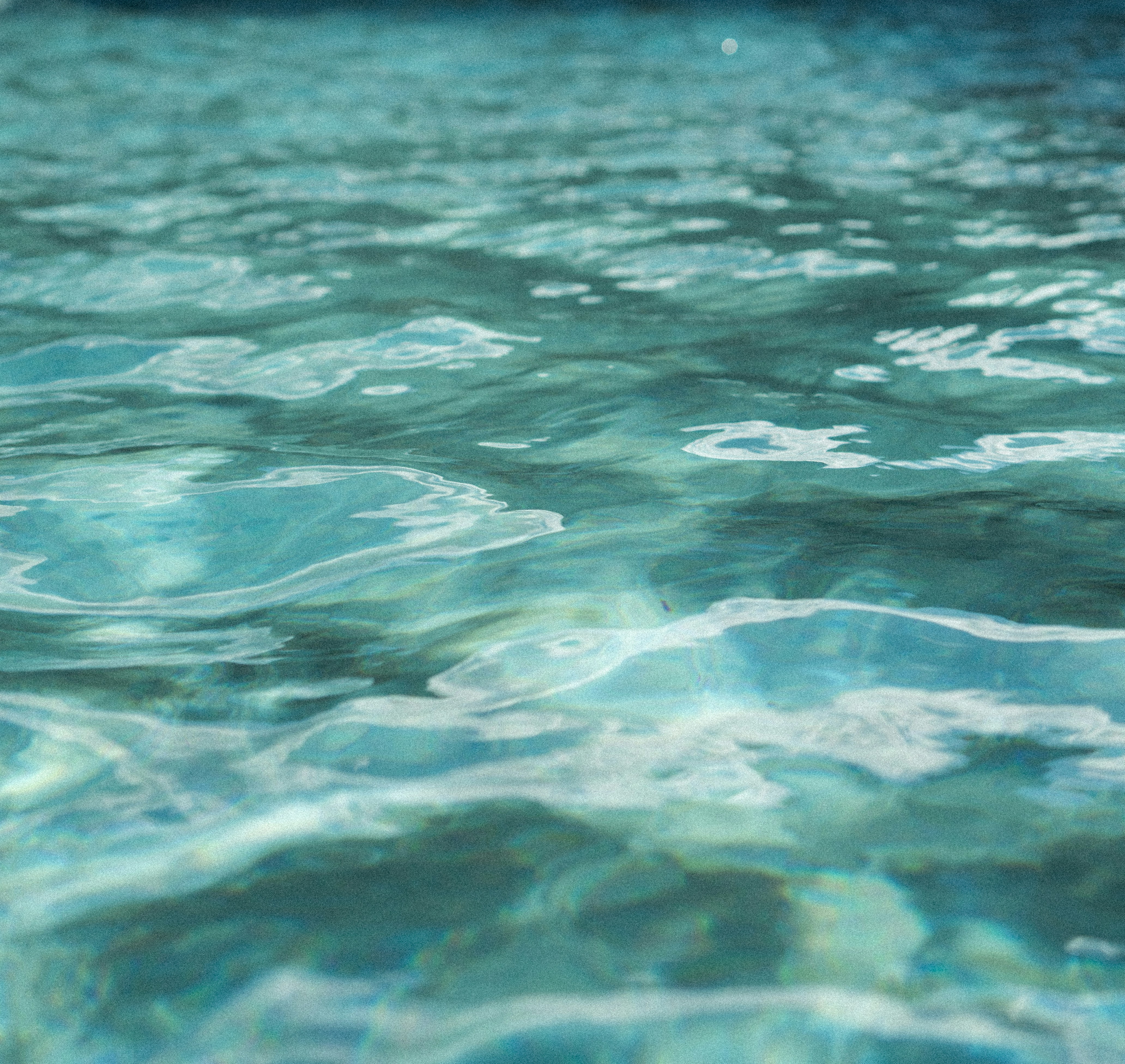 Sunlit Aqua: Quiet ripples on turquoise seascape