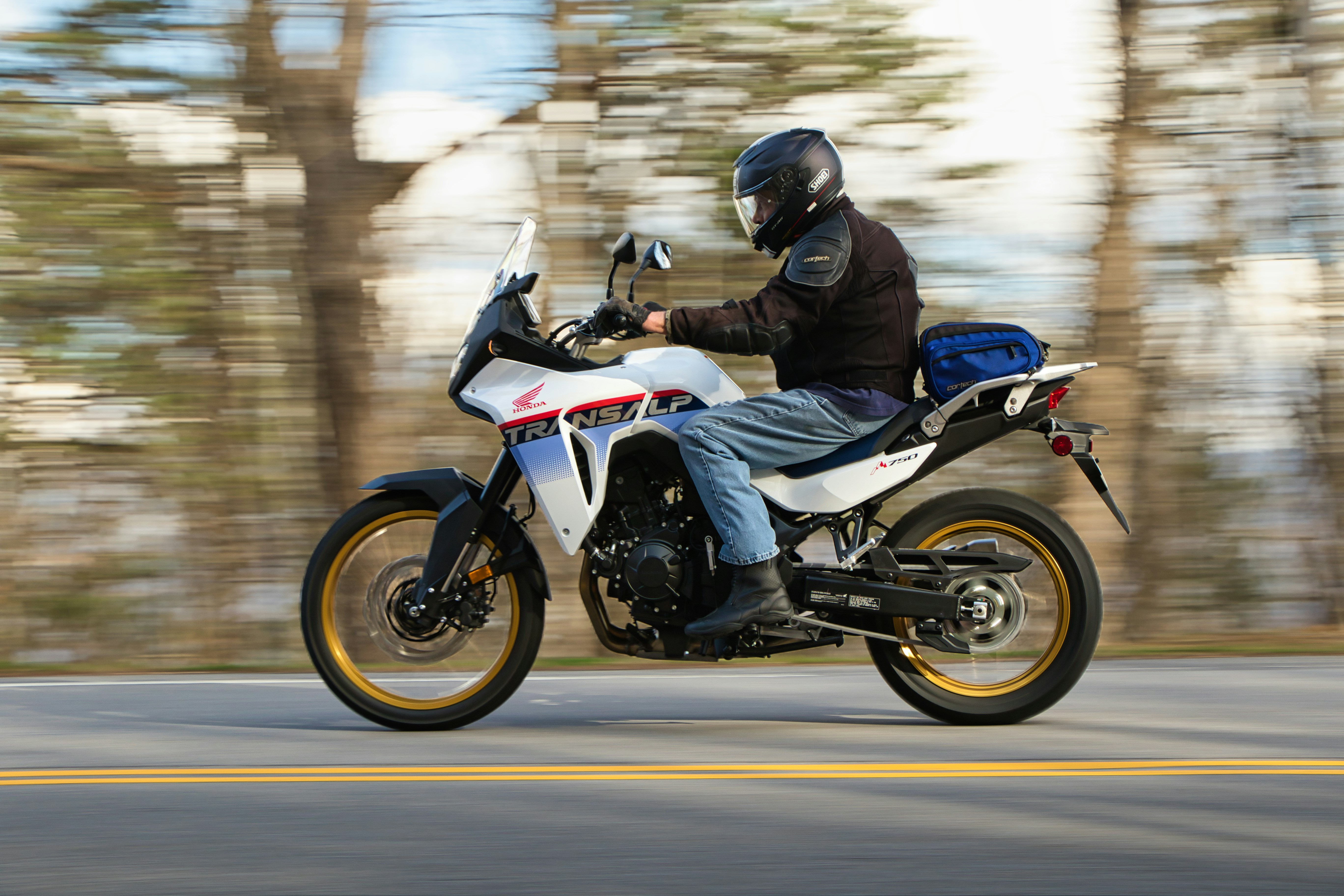 Mid-Mire Moto: Rider in Motion on a sharp white adventure bike