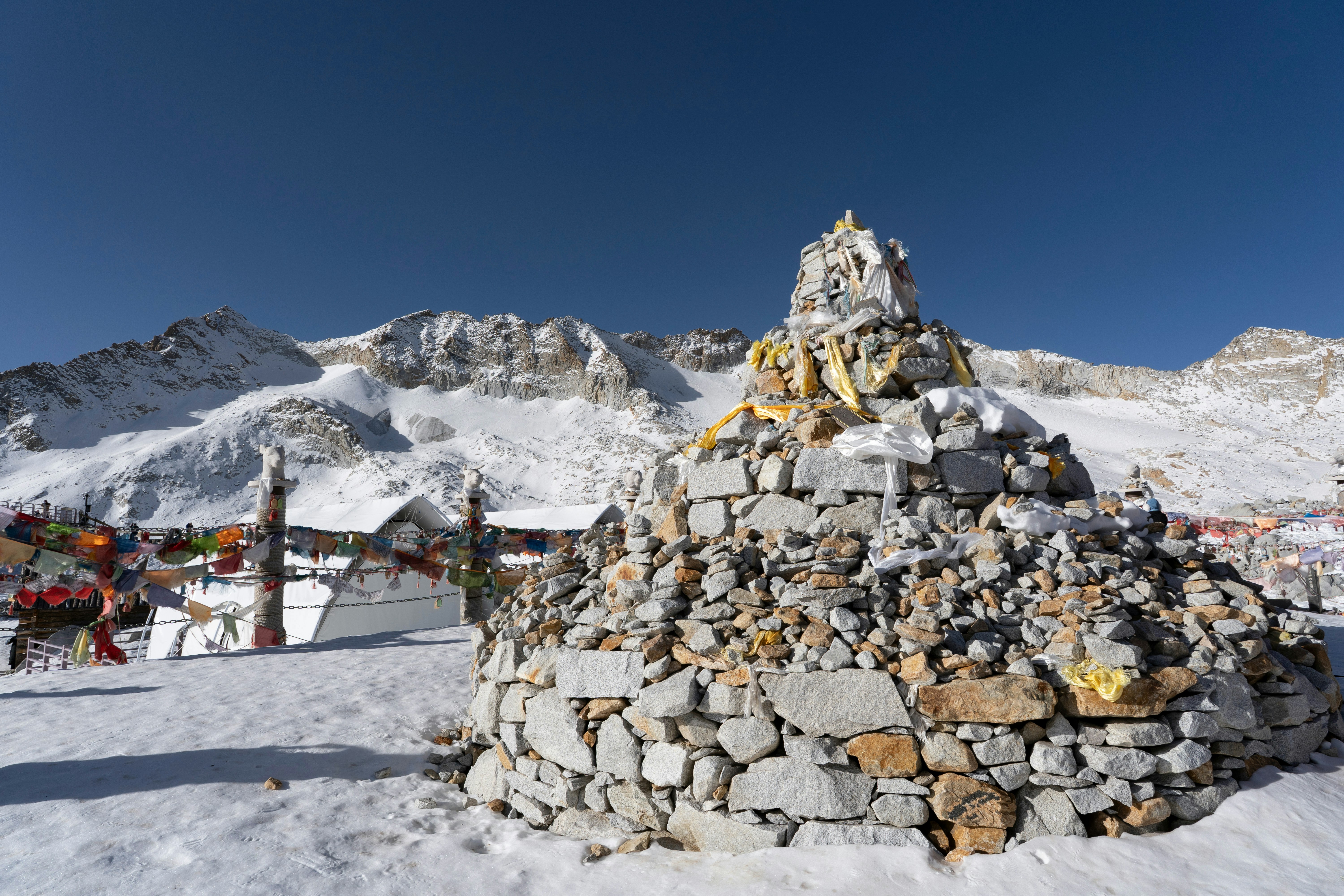 Prayer Cairn Amid Alpine Snow—Stone Inscribed Horizon