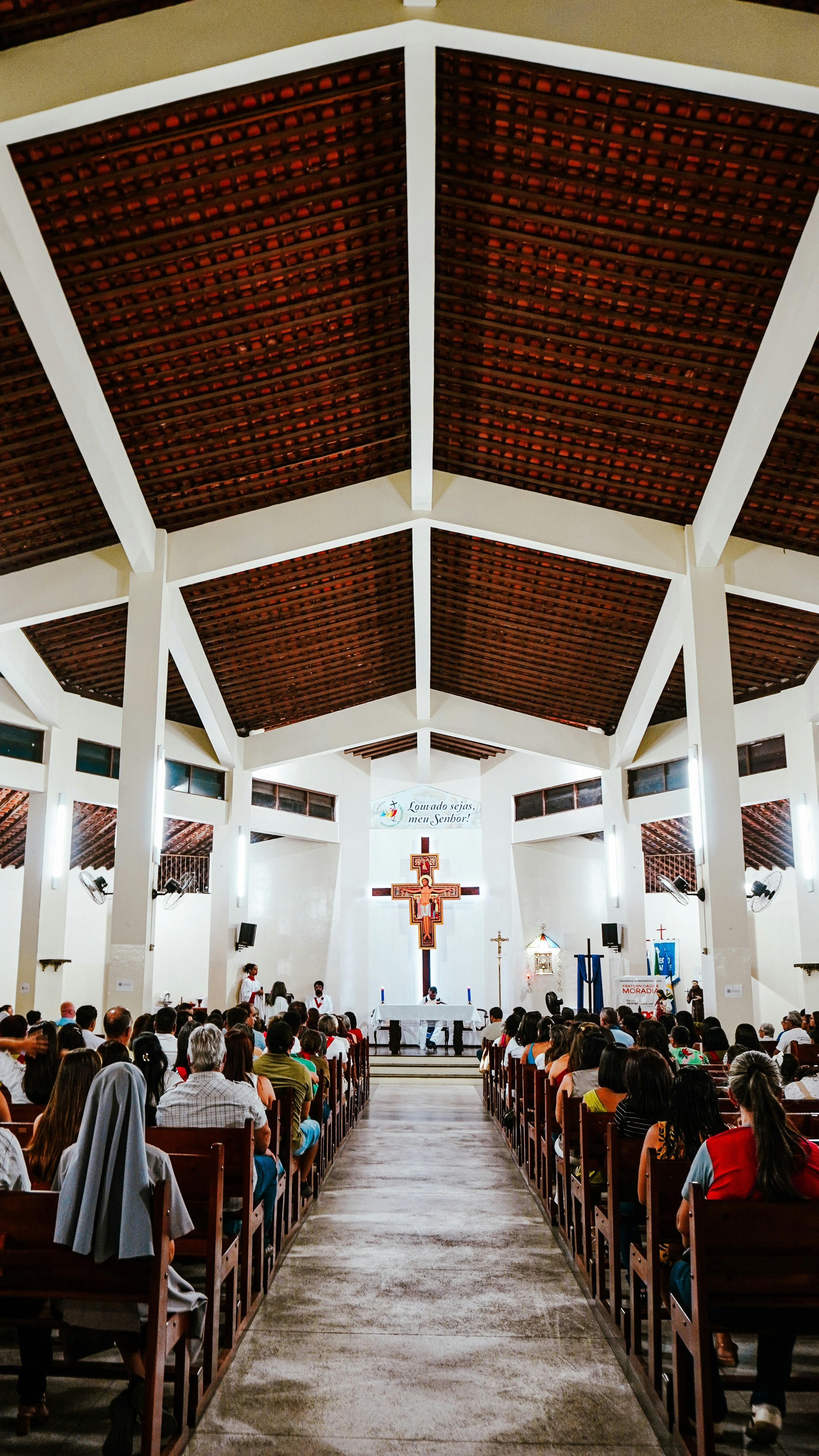A Quiet Cathedral: Rows of Worship Facing the Cruciform Altar