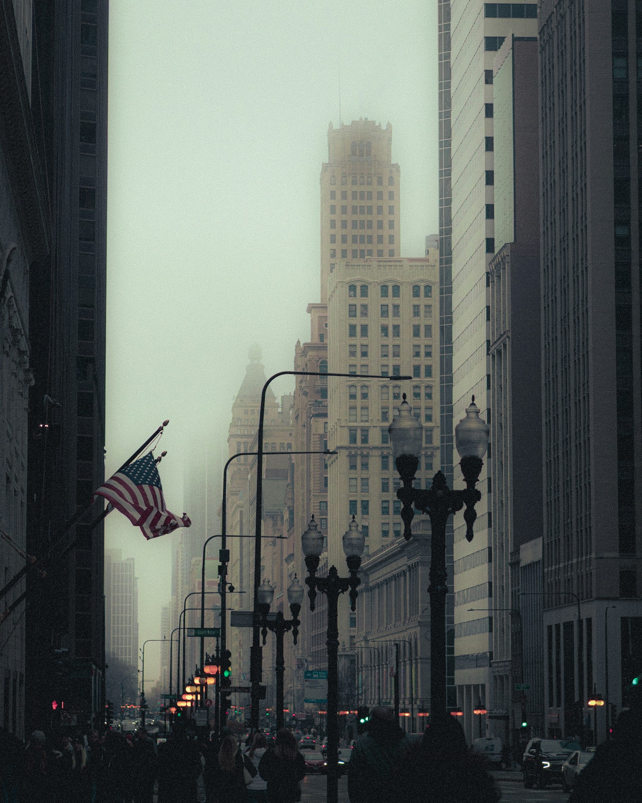 American Flag and Street Lamps Piercing the Foggy Downtown