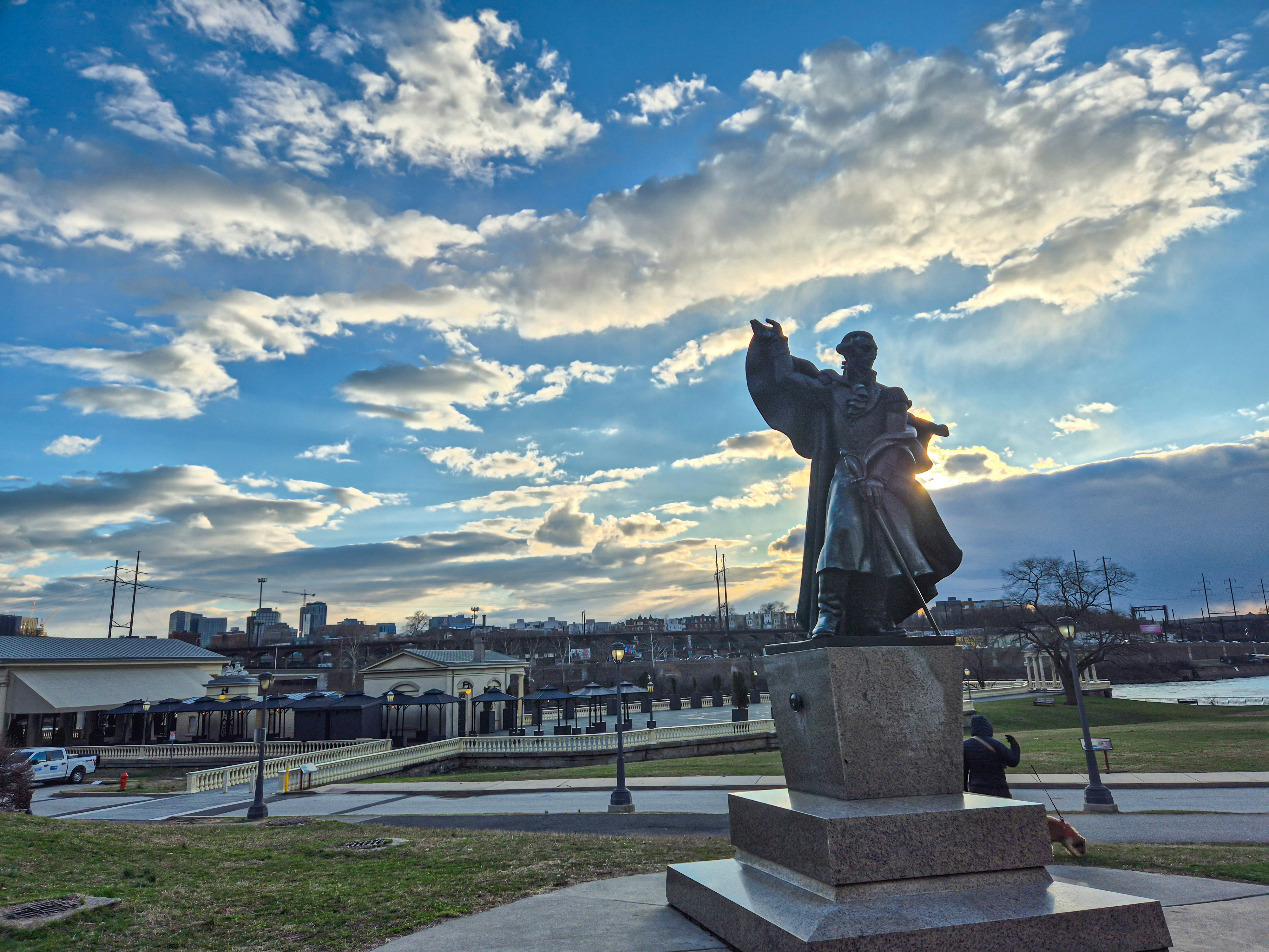 Statue Gaze Over Riverside: A Monumental Moment at Dusk