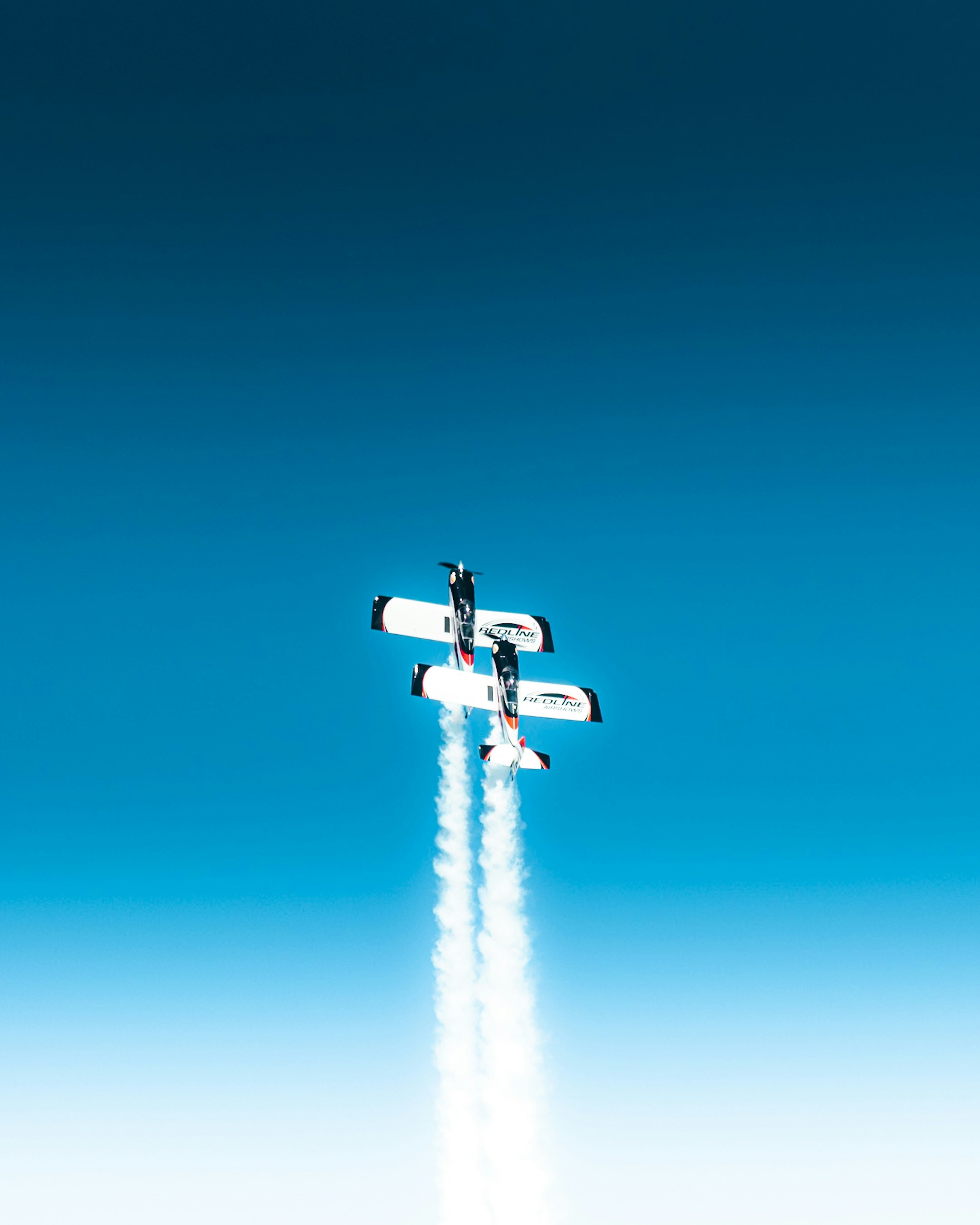 Skybound Duo: Aerobatic Duo Sprinting Through Blue