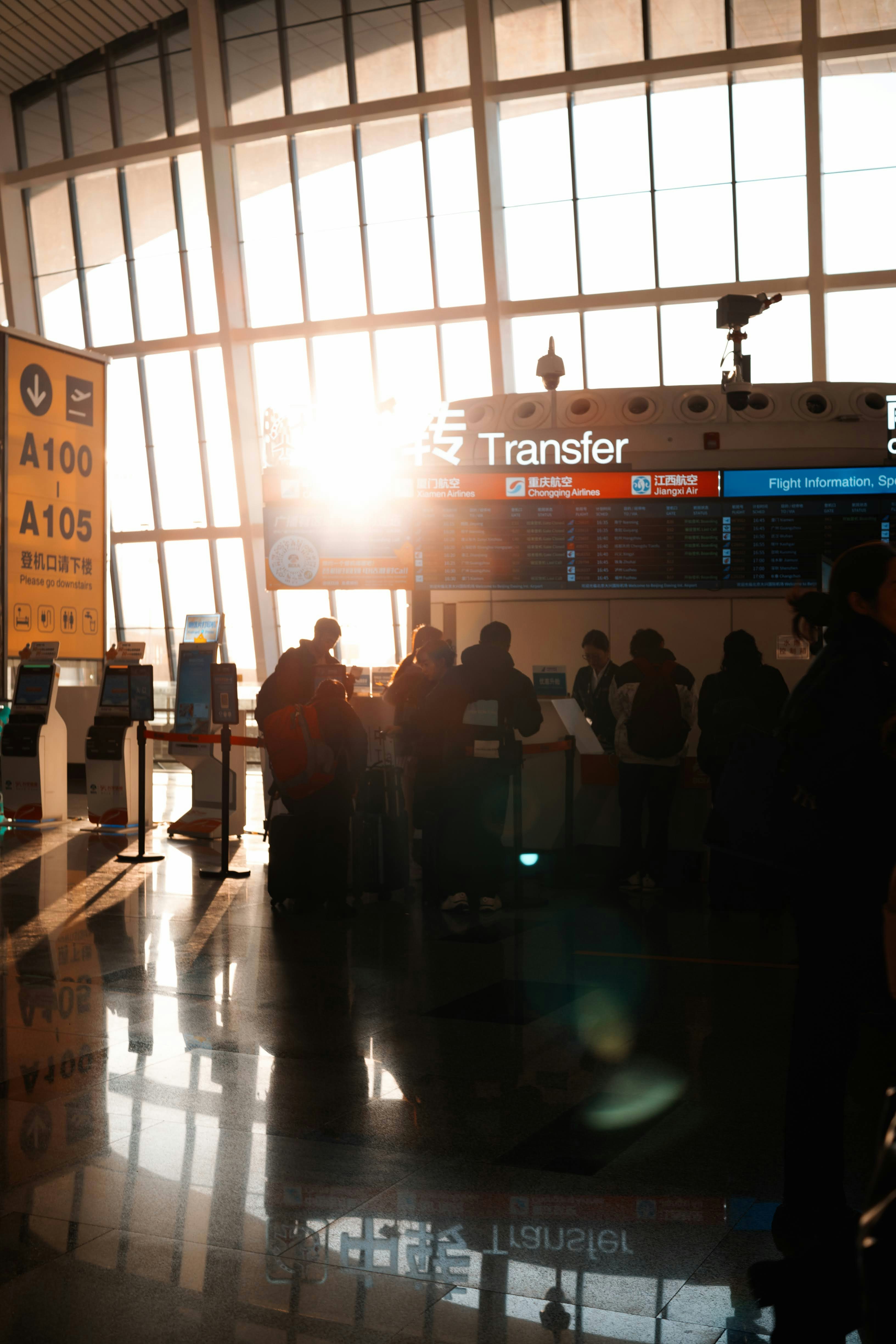 Sunlit Departure Hall: Silhouettes at the Check-In Barrier