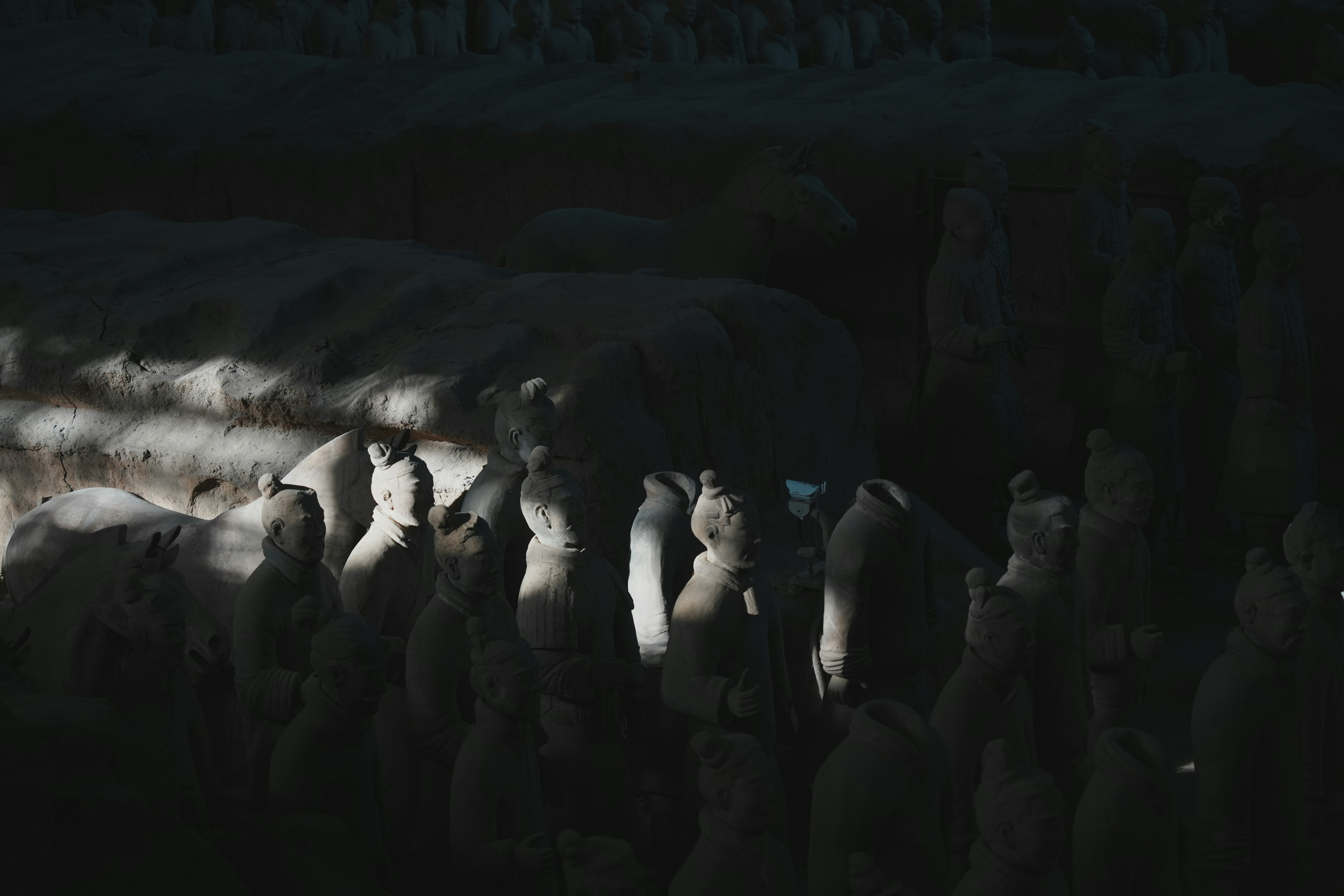 Hidden Parade: Stone Figures Emergent in Slanting Light