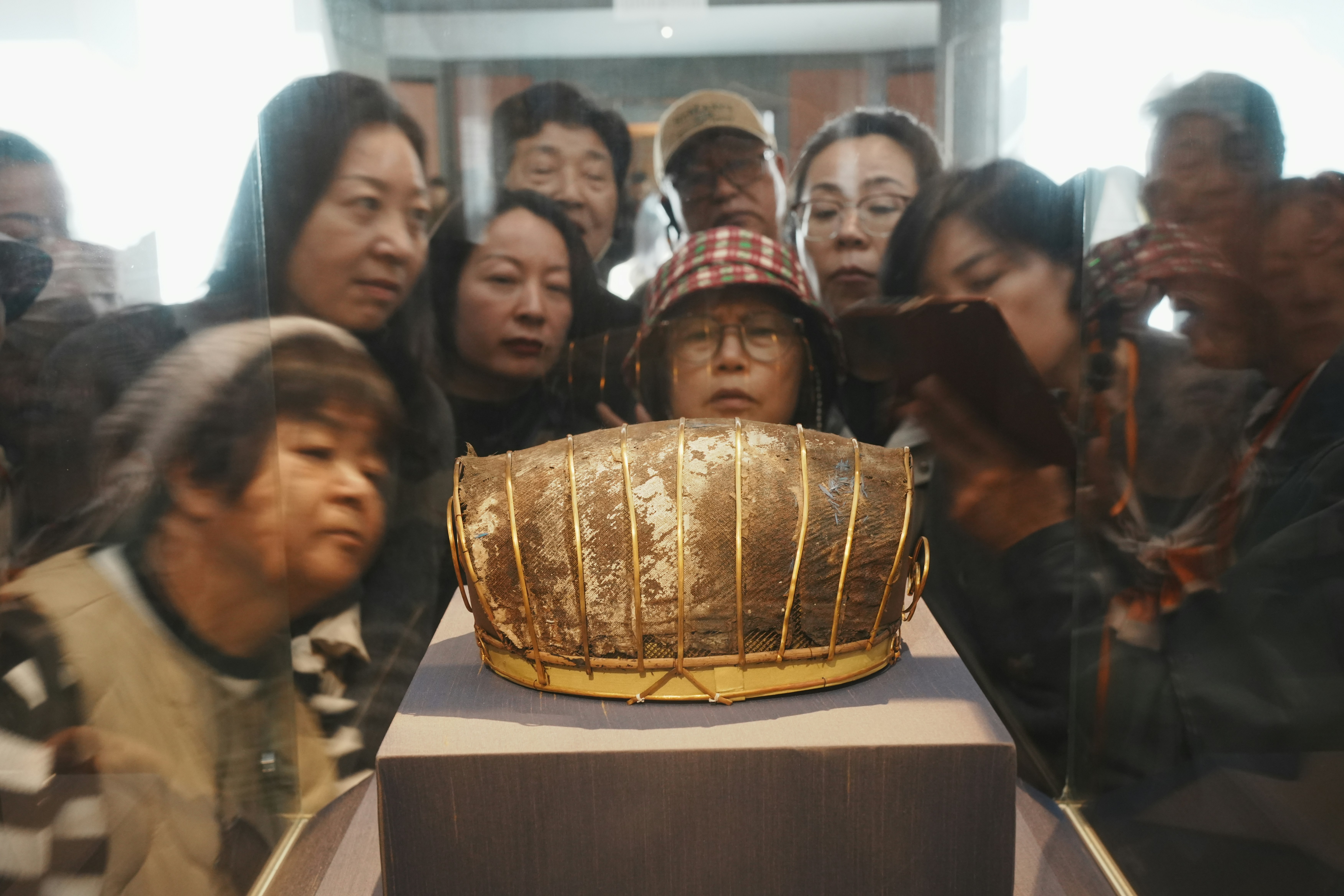 Crowd Gazes Upon a Central Artifact: A Glowing Crown of Time