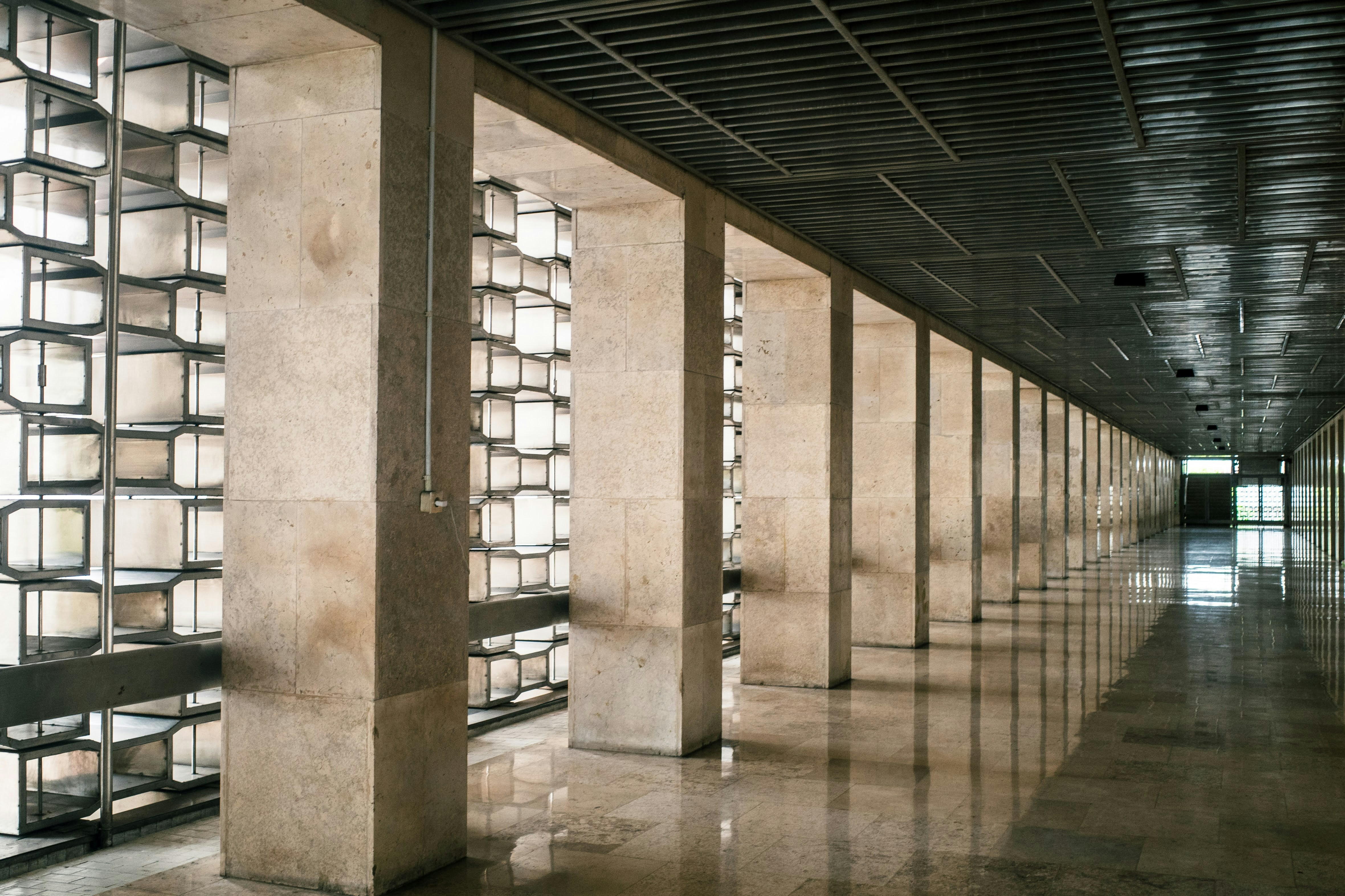 Echoes of Concrete: A Silvery Corridor of Columns and Light