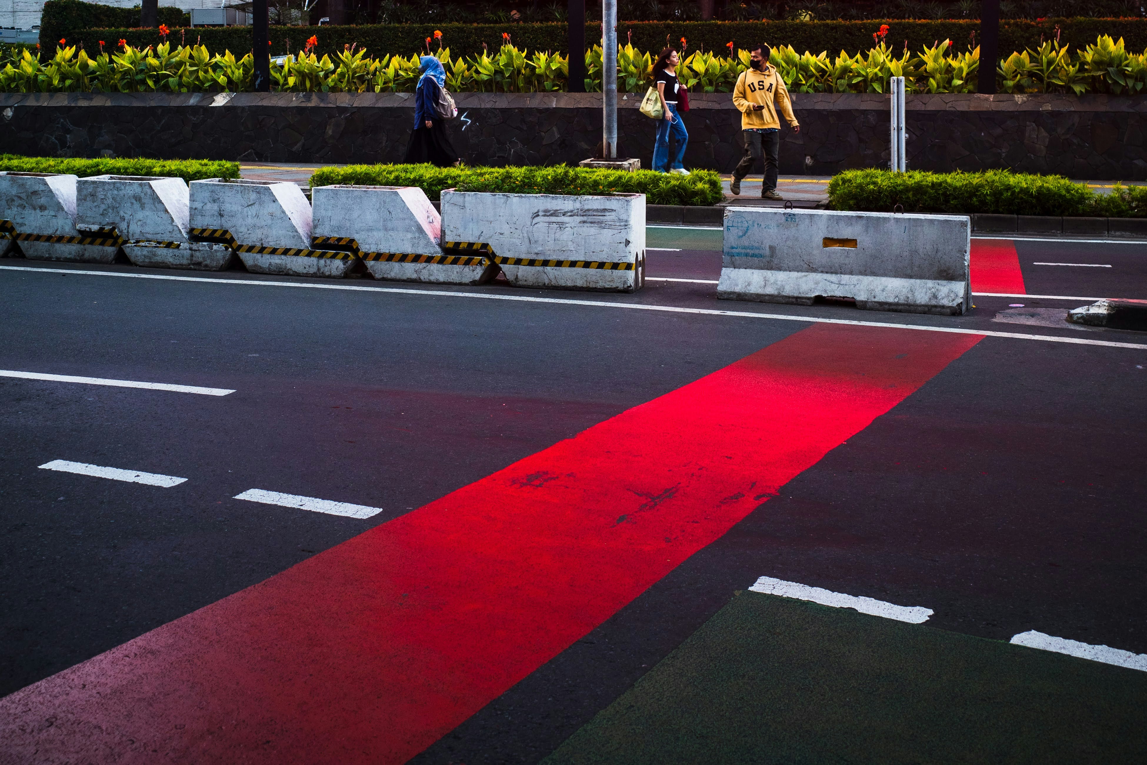Red Pedestrian Crossing Slice Across a Quiet City Street