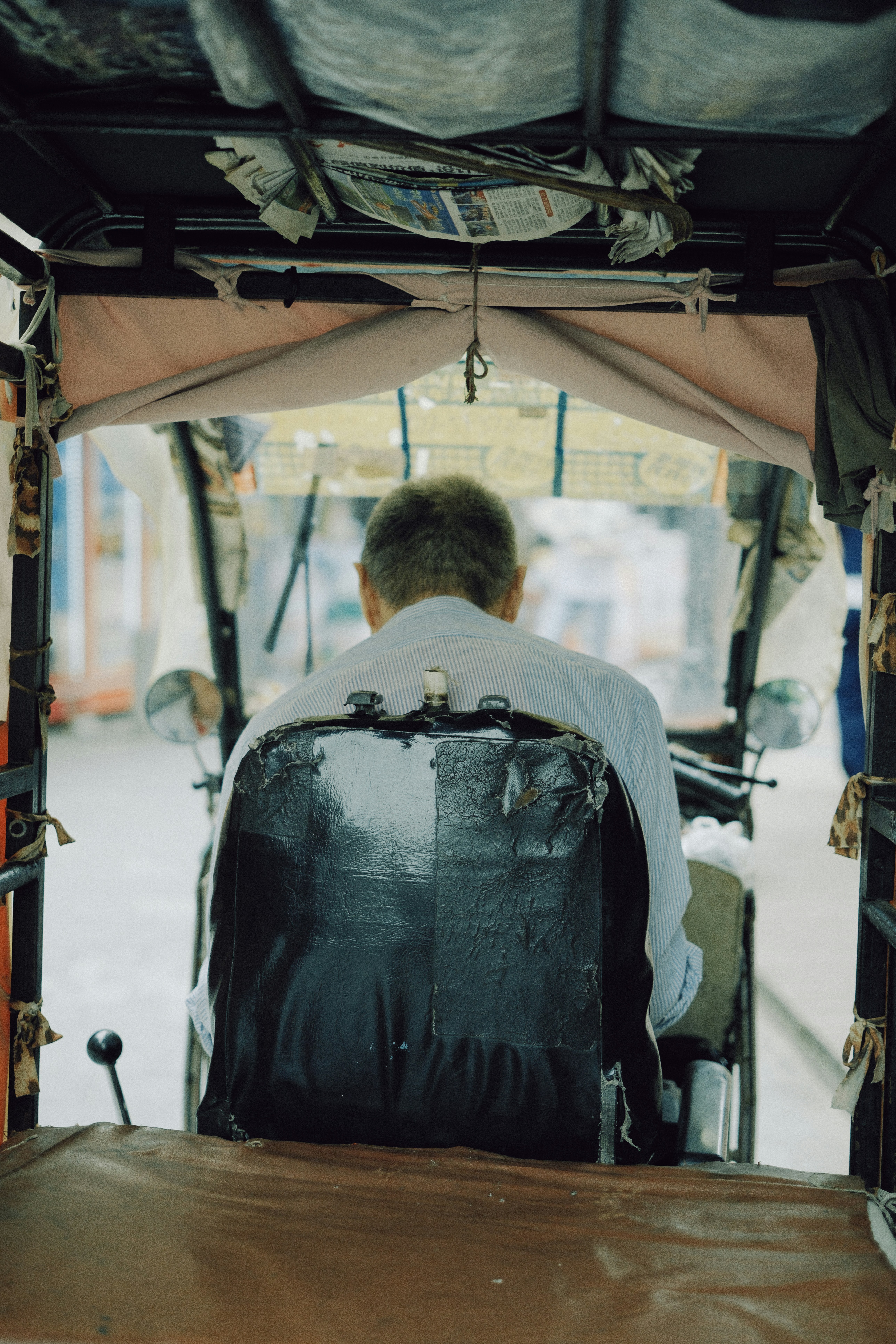 Rear View of a Commuter: A Humble Ride Through a Narrow Canopy