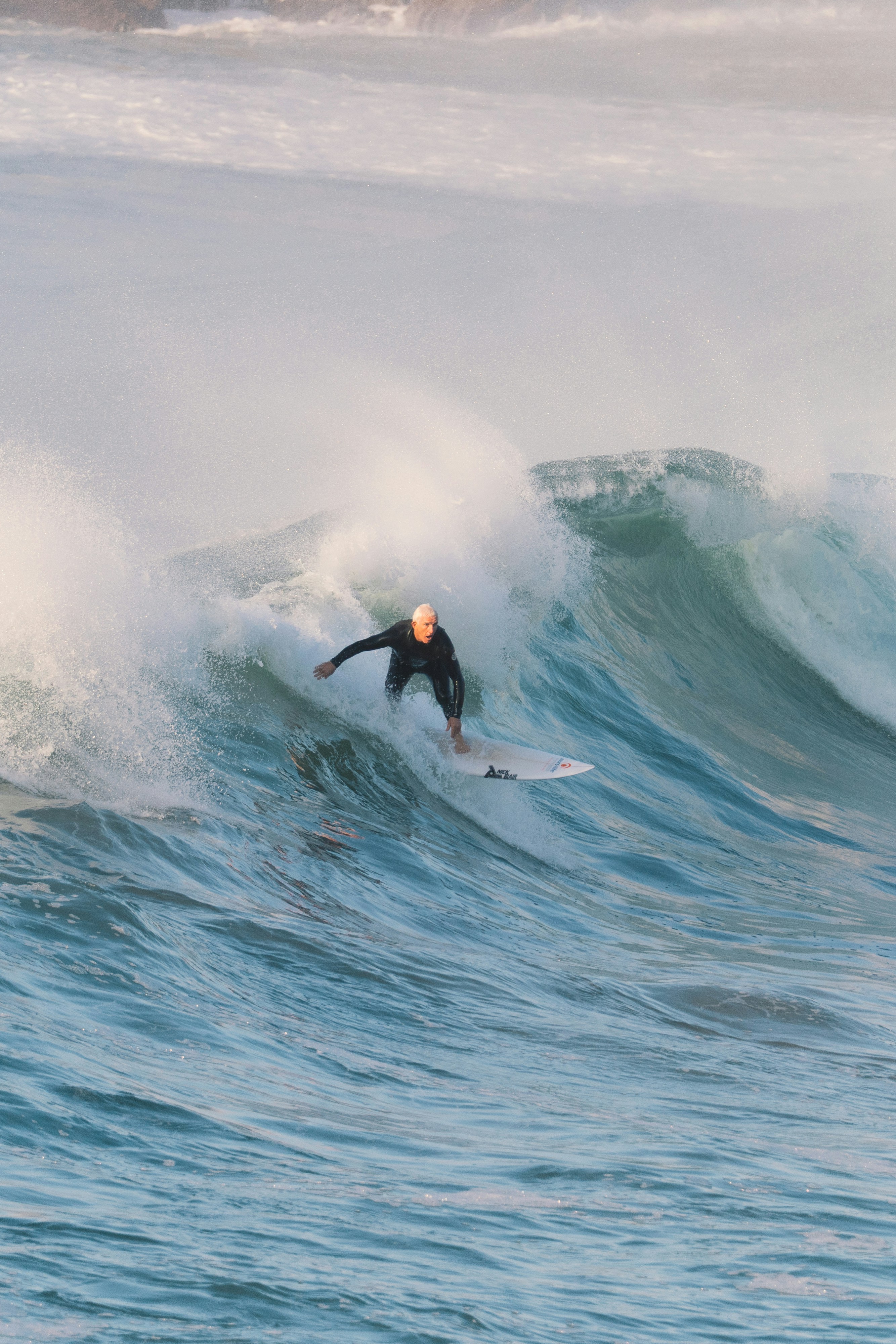Rider in the Tube: a lone surfer carving through a turquoise Atlantic-like barrel