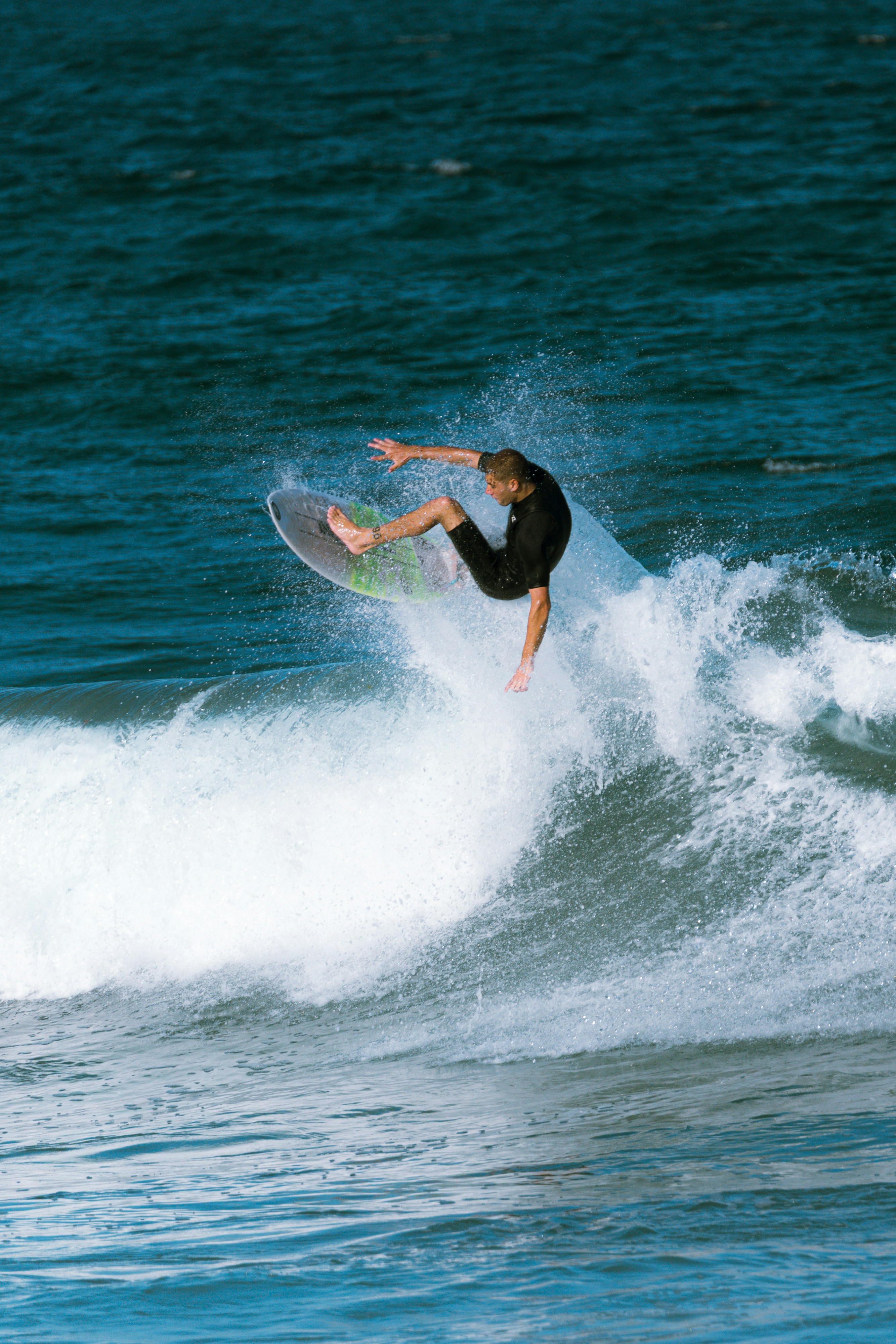 High Surf Frontside: A surfer in mid-air above a breaking crest