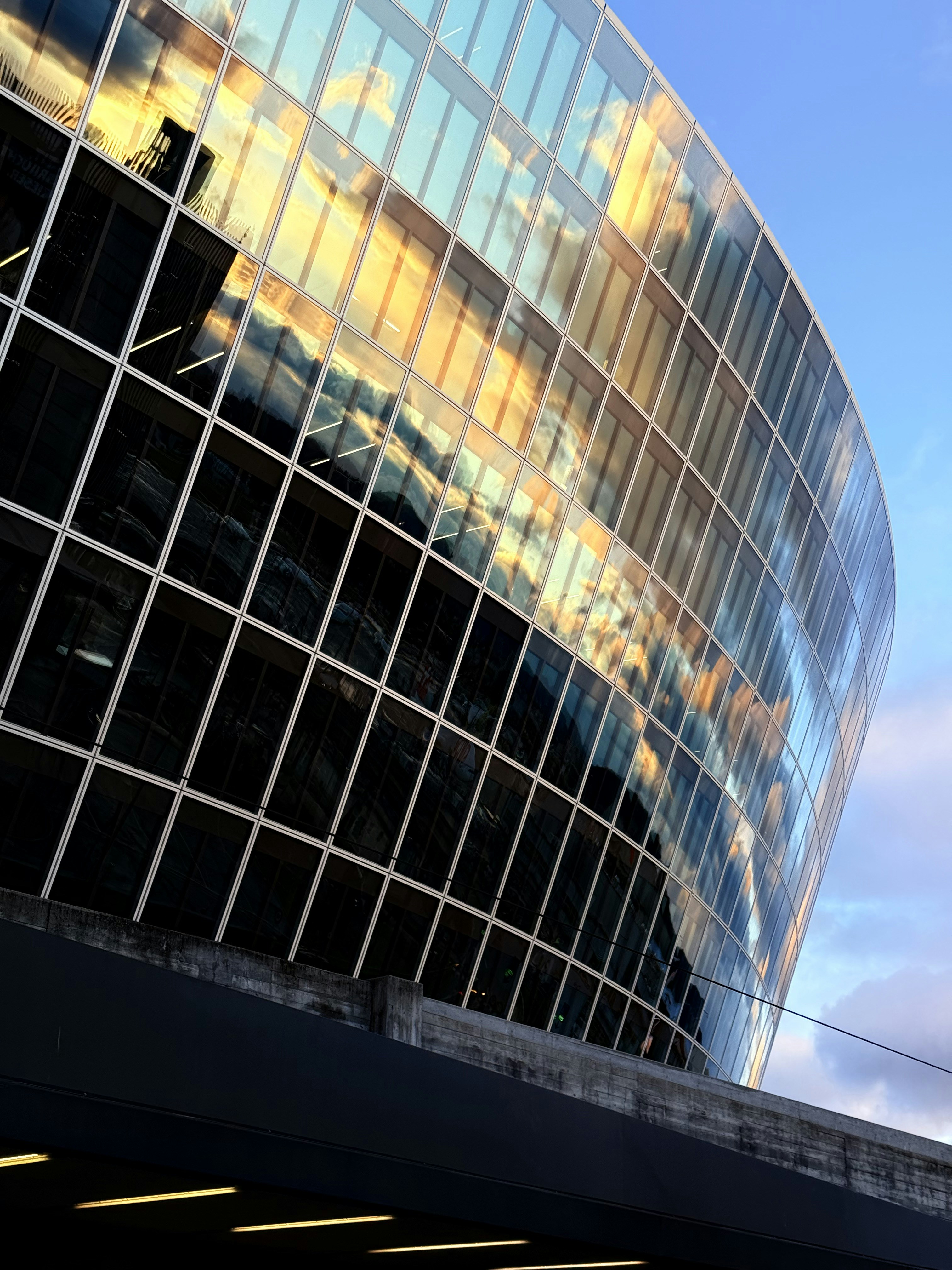 Reflected Glass Arc: Sunset Stripes on a Modern Curve