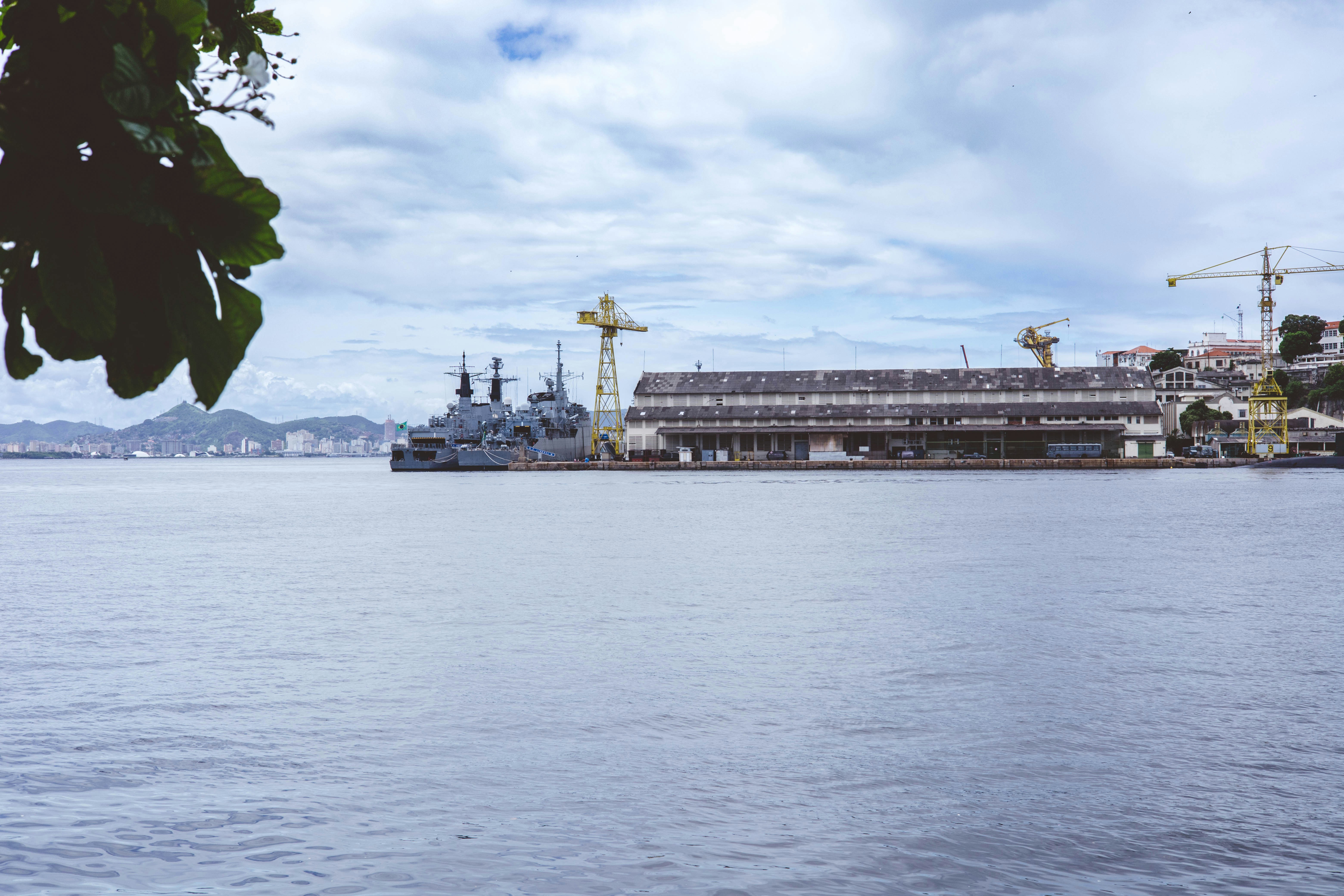 Harbor Crane Horizon: Industrial Dockfront Across Calm Waters