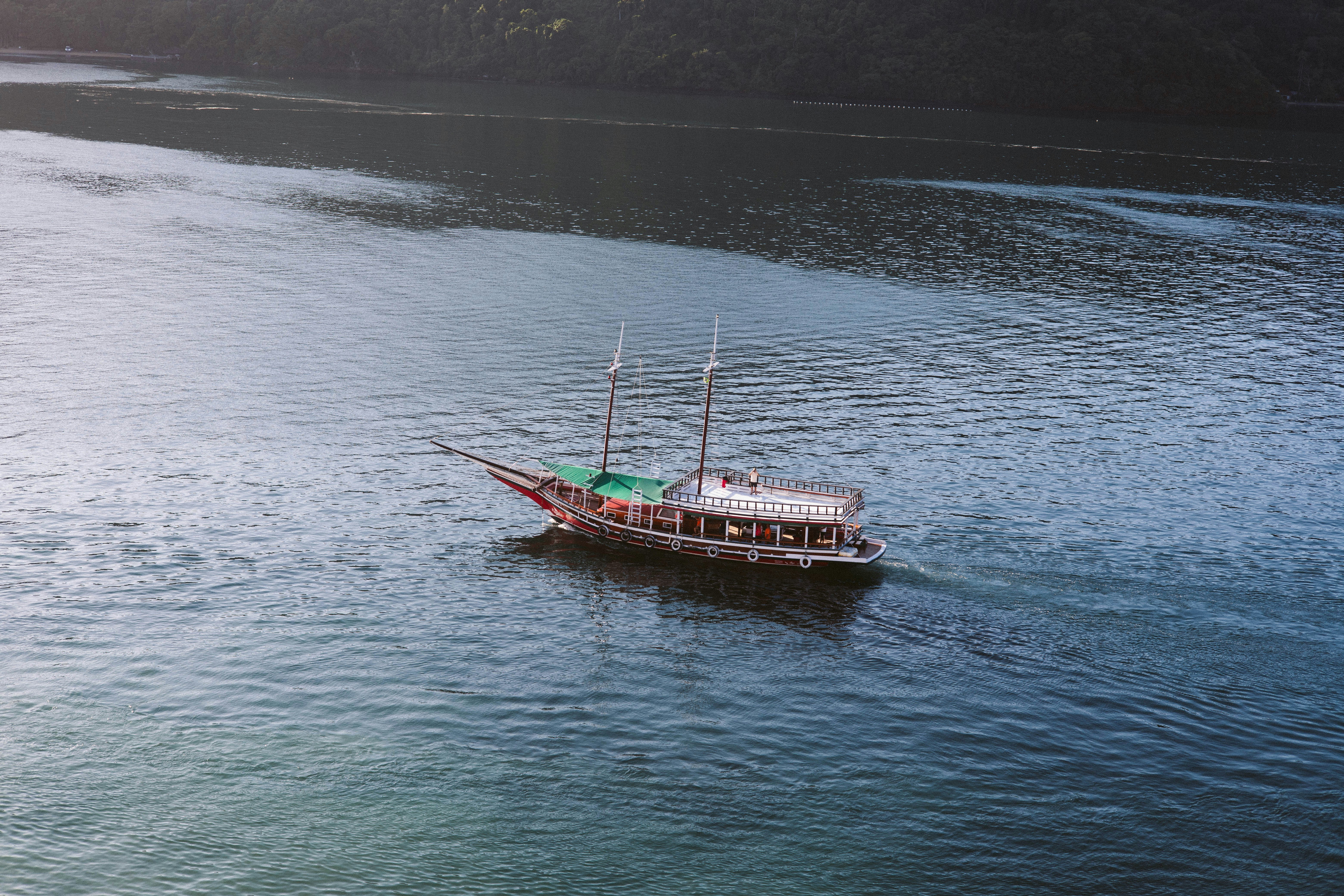 Lone Paddle Steamer Gliding Across Quiet Blue Waters