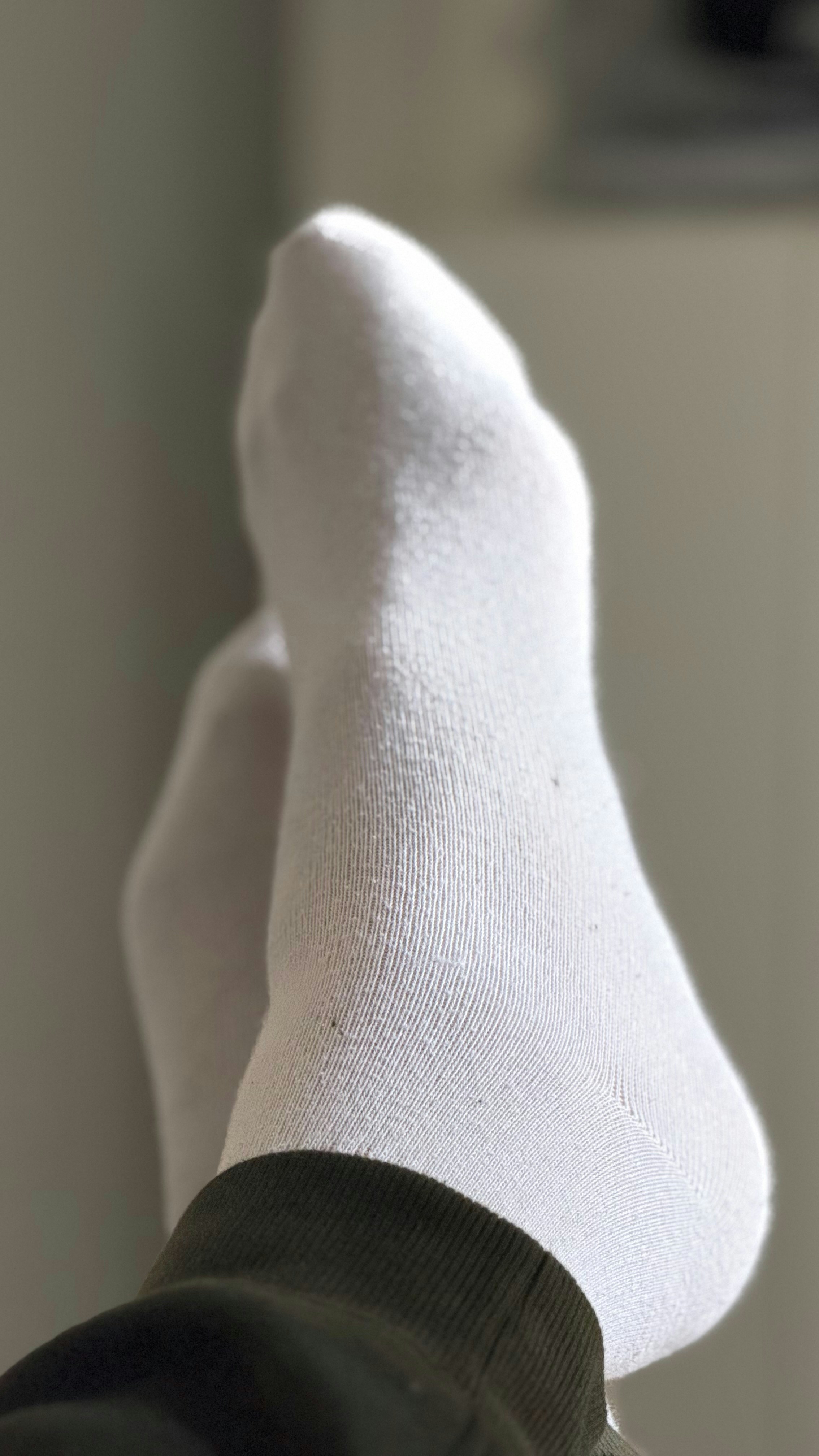 White Foot in Focus: A Minimalist Sock Portrait