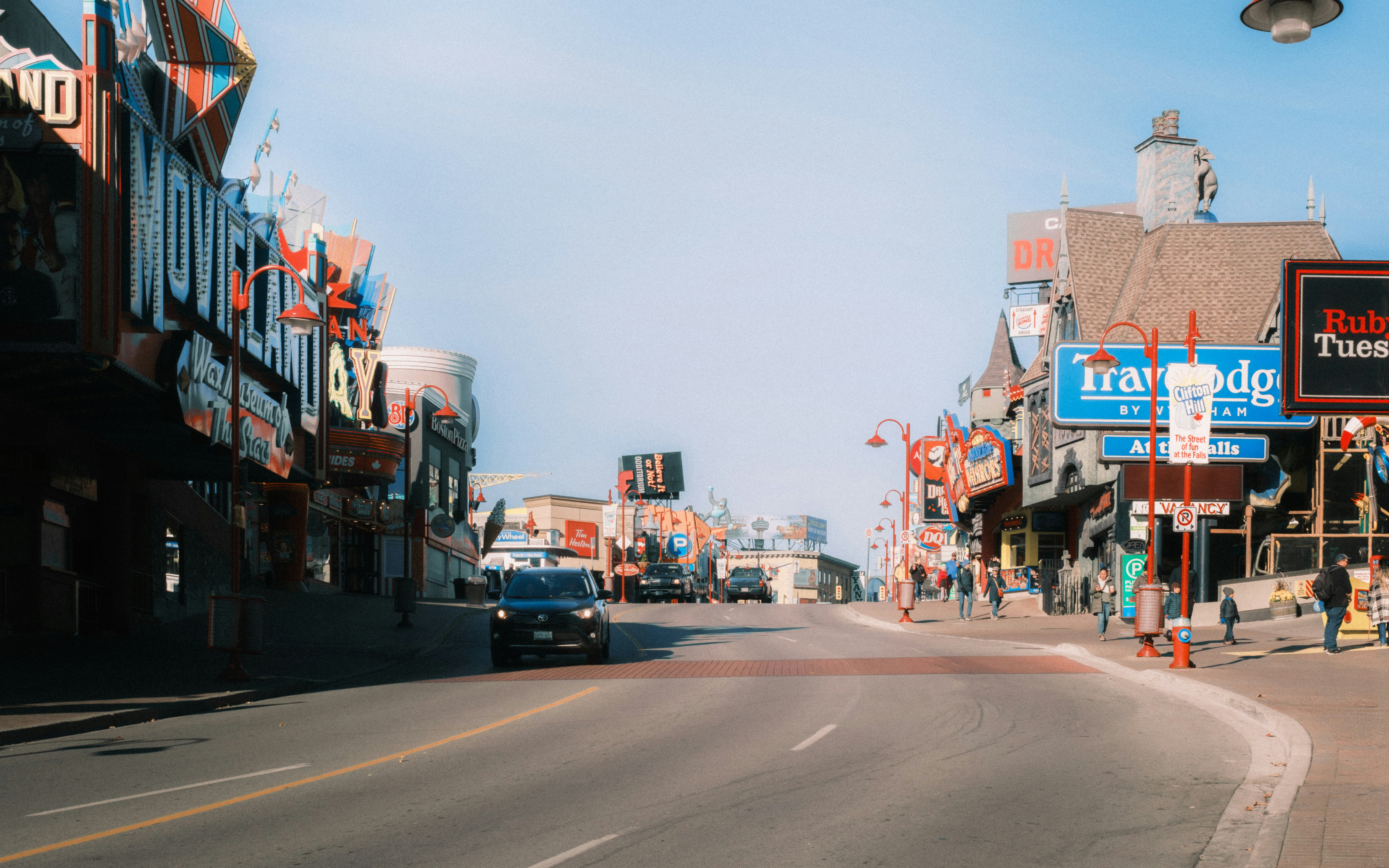 Neon Boulevard: A Sunlit Street Corner in Retro Signage