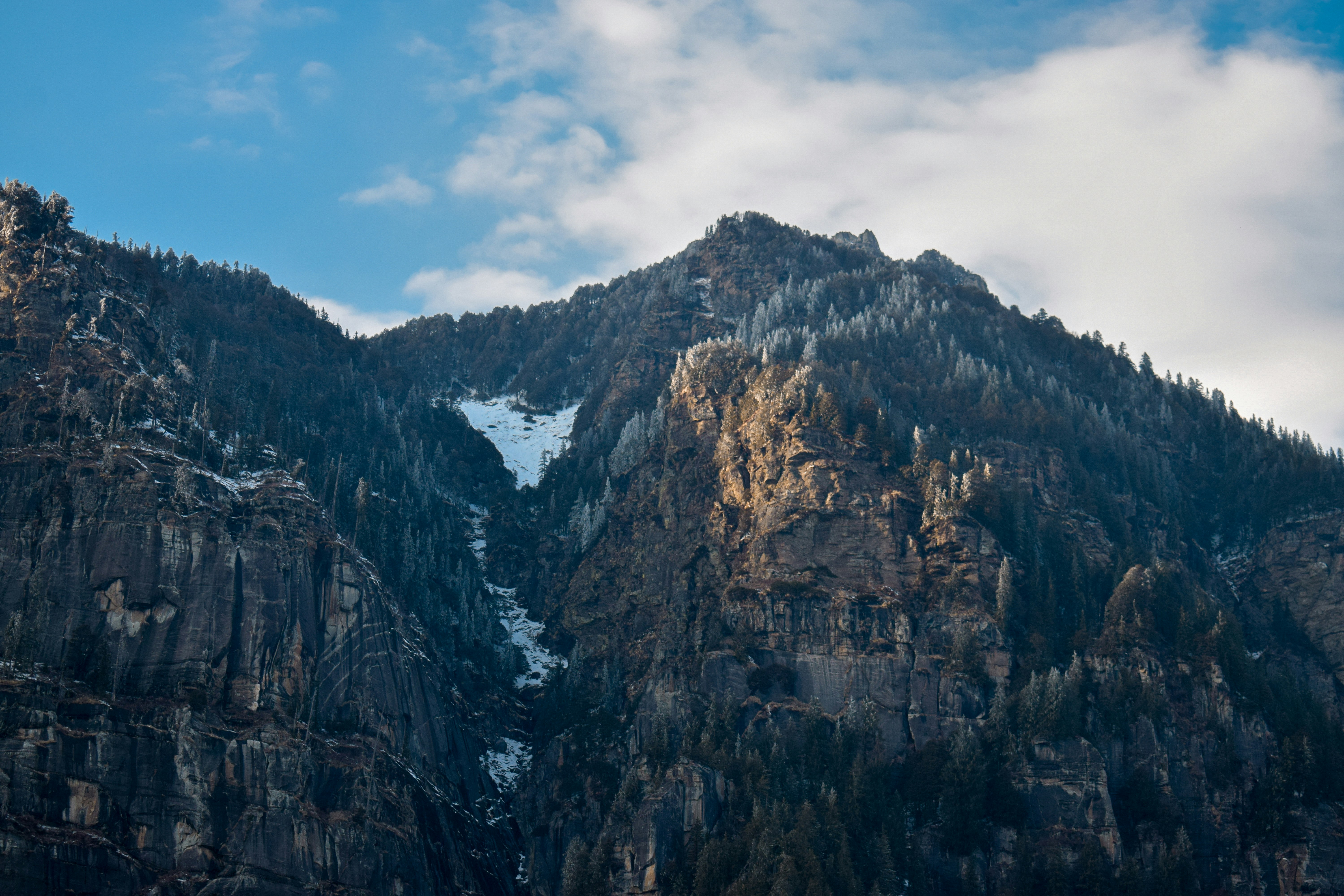 Snow-kissed summit under a blue sky