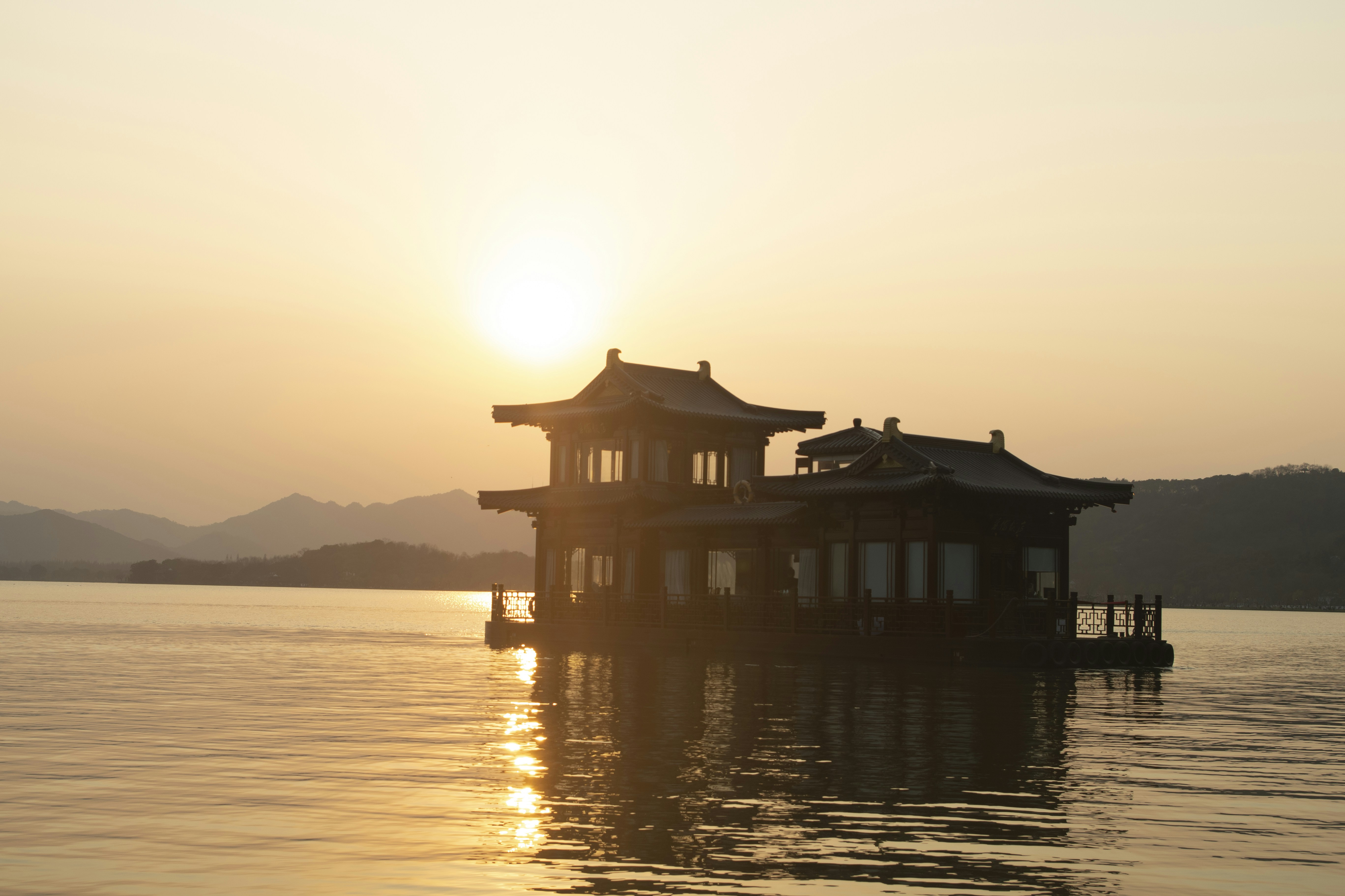 Sunlit Pagoda at Dusk: A Tranquil Lake Refuge