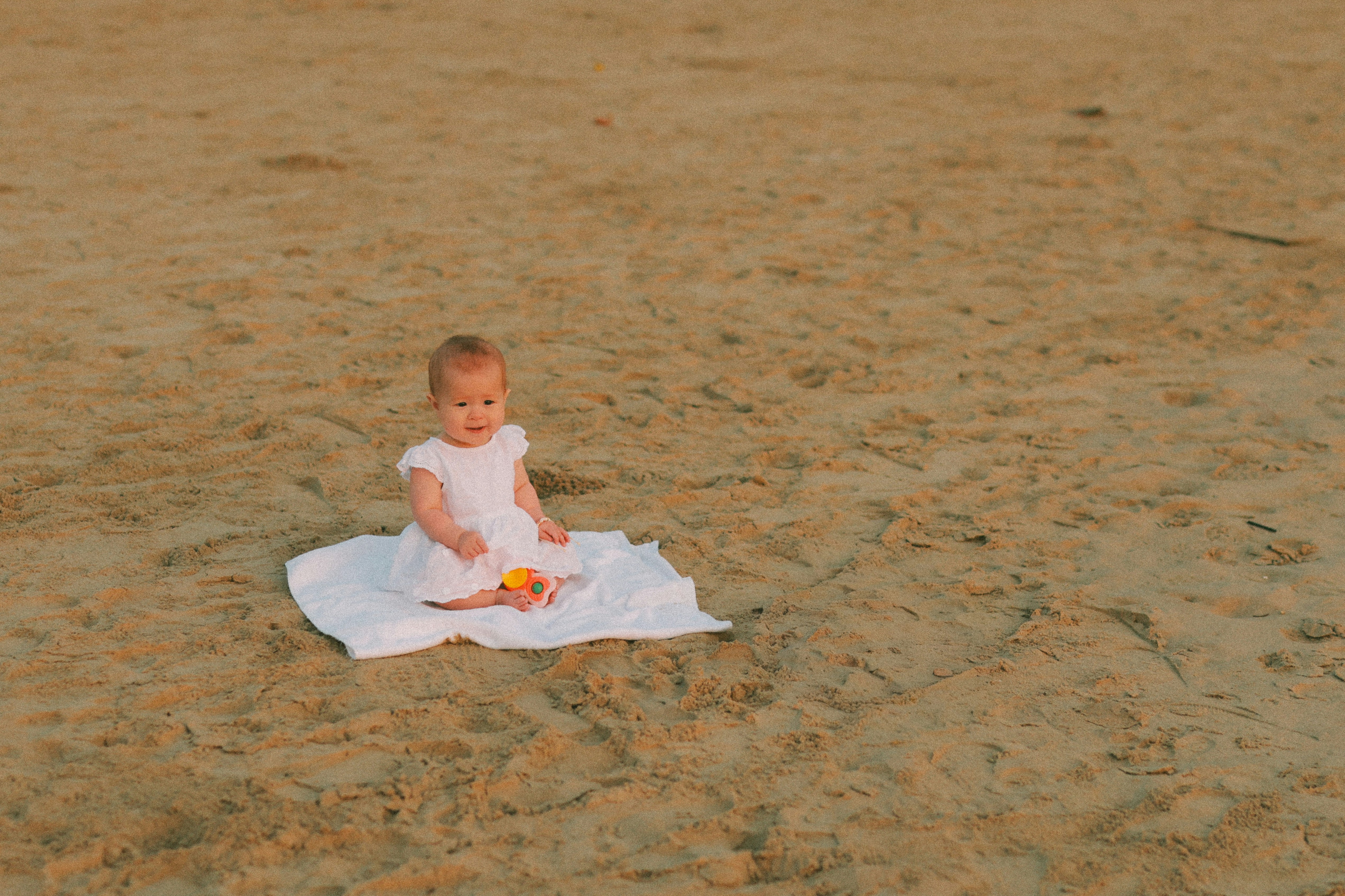Sunlit Baby on a Deserted Beach Blanket