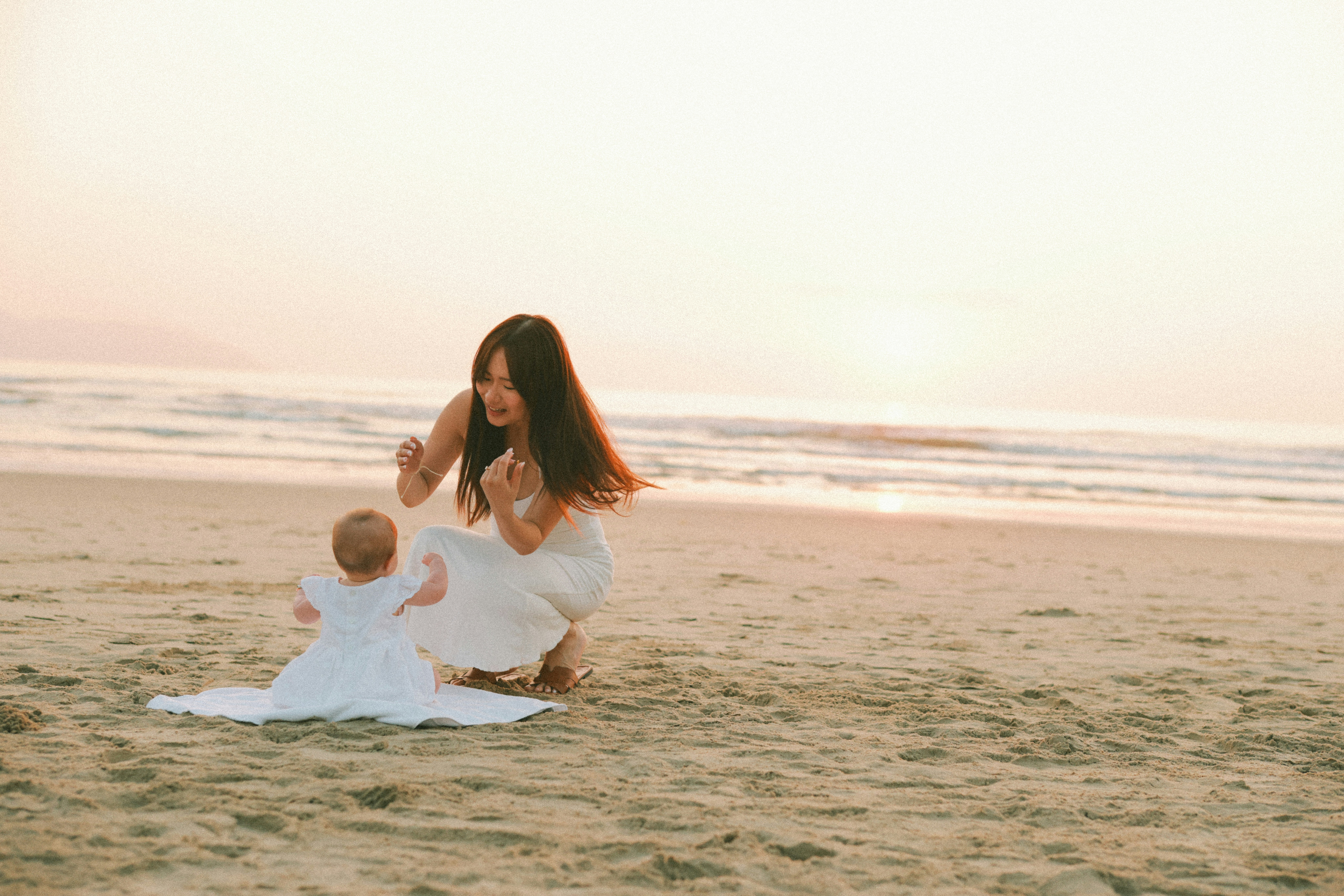 Beachside Moment: Mother's Gaze and Baby's First Steps