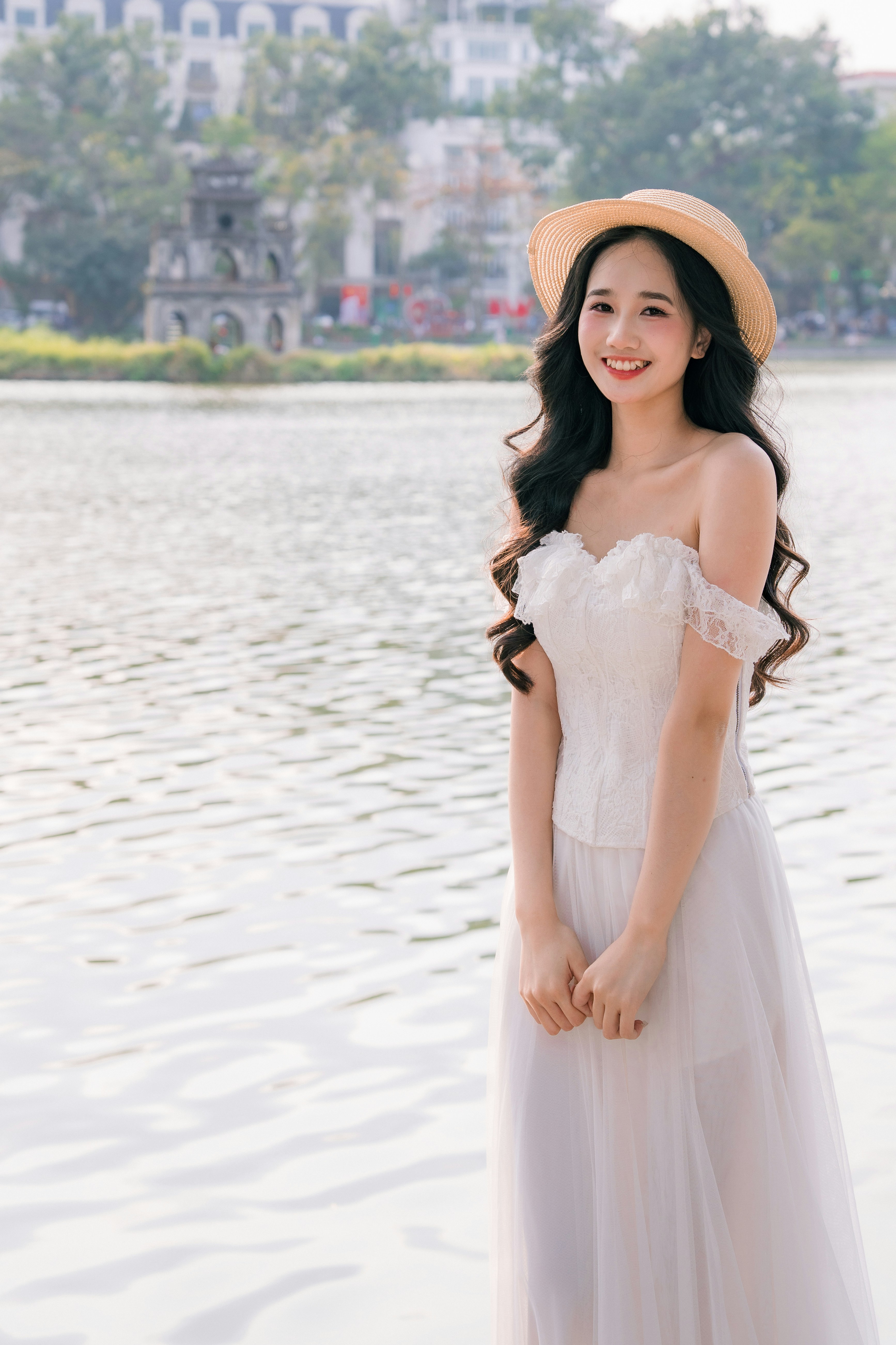 Portrait by the Water: A Quiet Smile in White