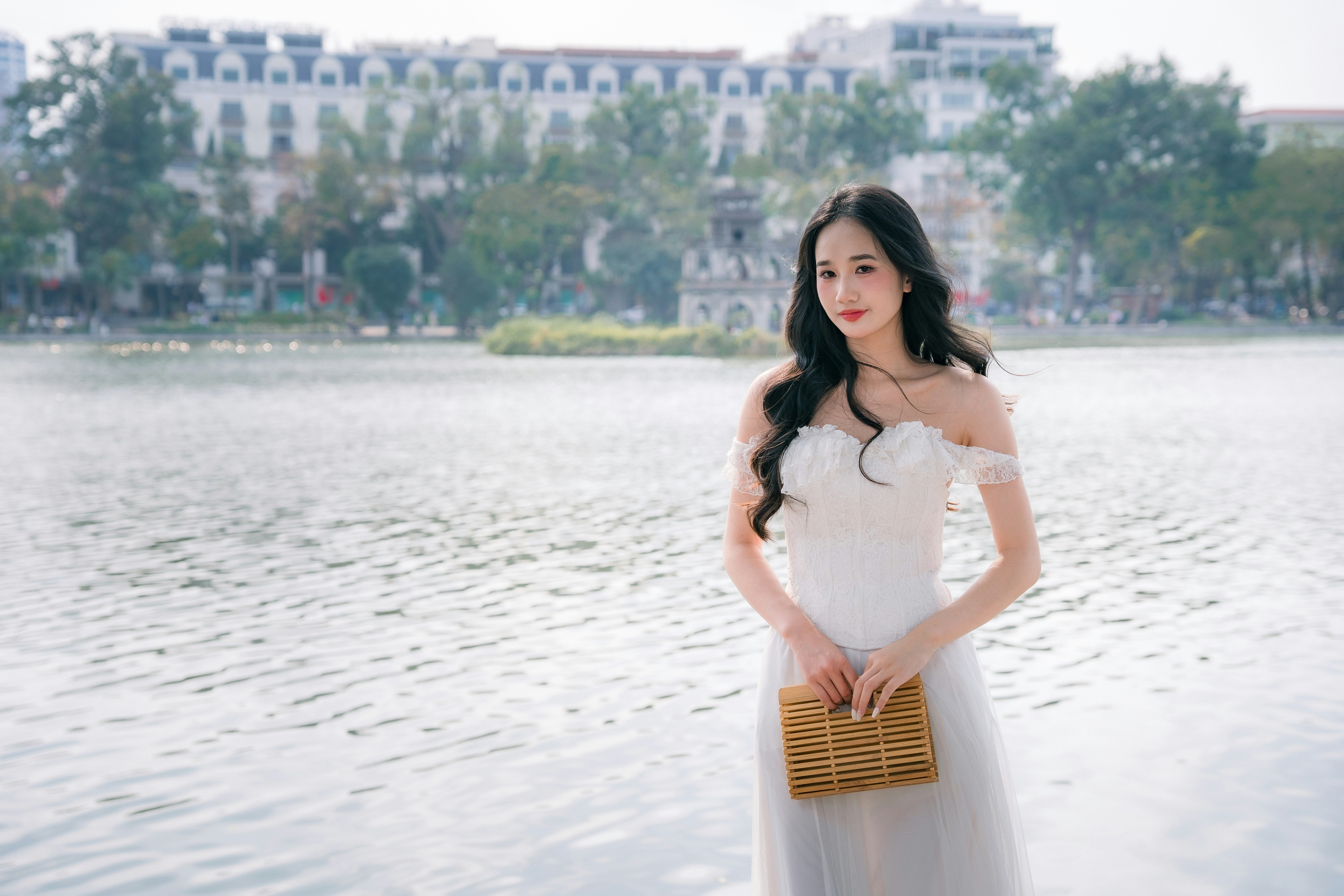 White-dress silhouette by the lakeside