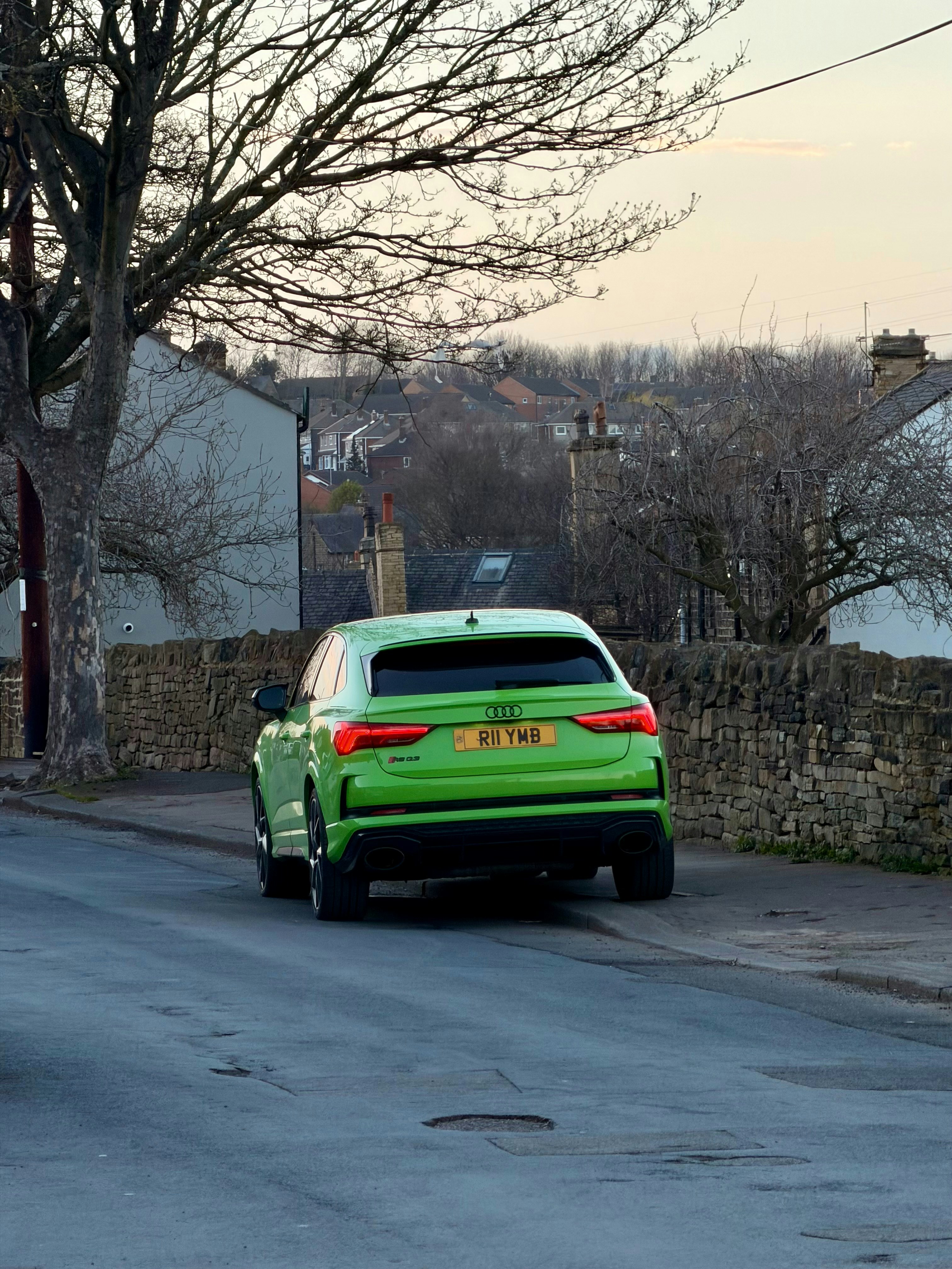 Lime Green Audi Resting on a Quiet Village Street