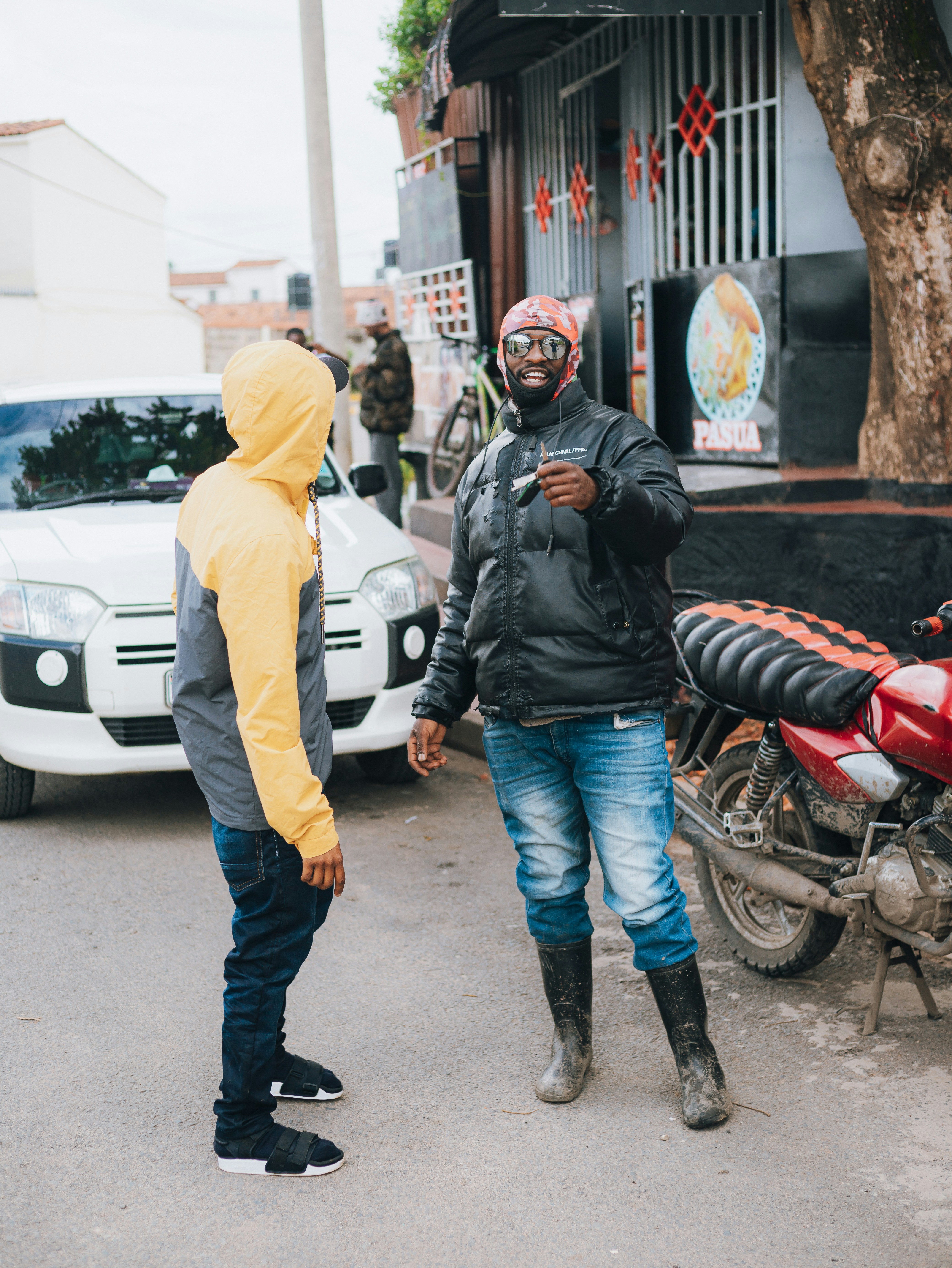 Gesture of Welcome: A Friendly Exchange outside a Market Street