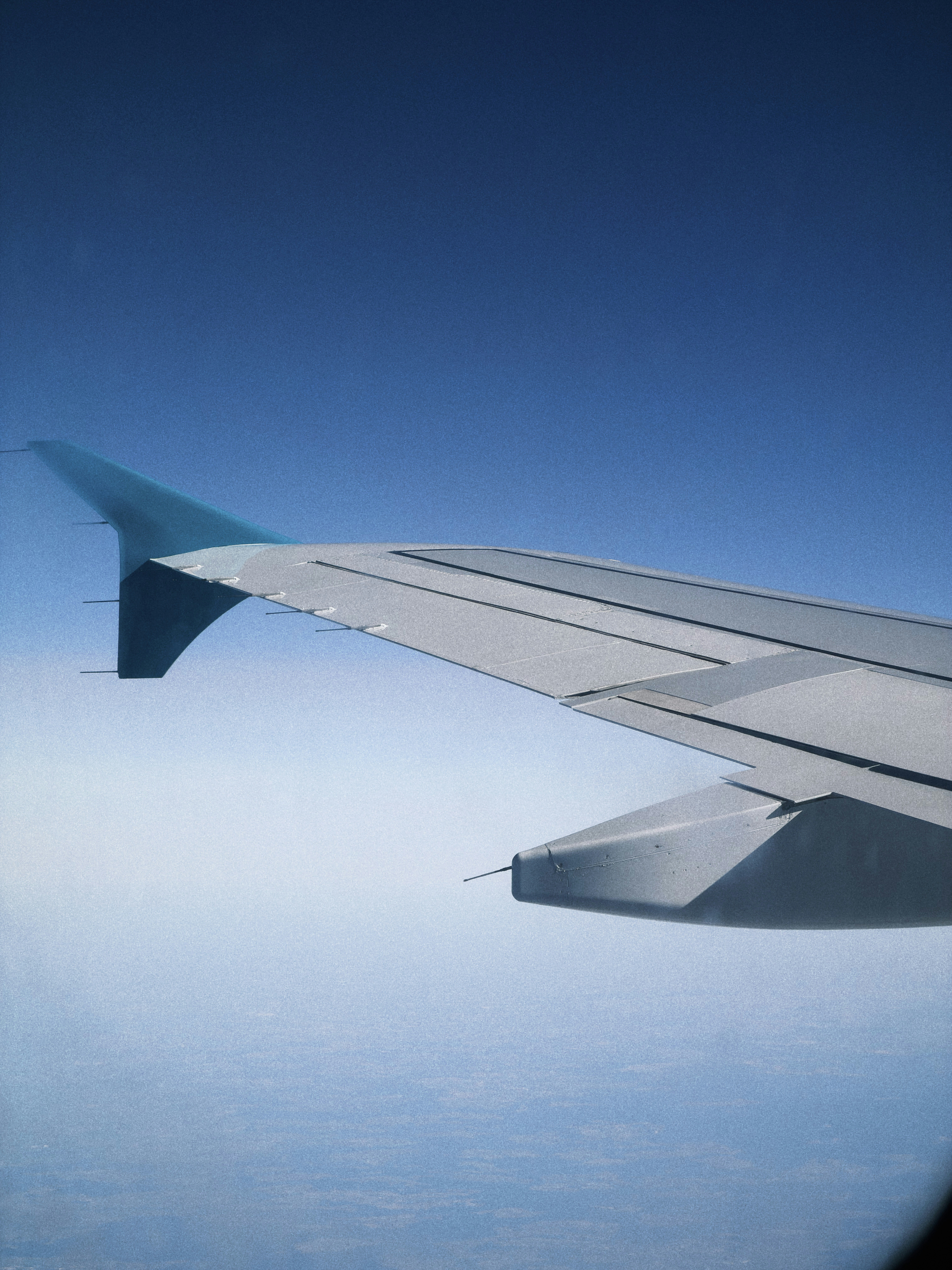 Wingtip in the Sky: A Quiet Flight Over Blue Expanse