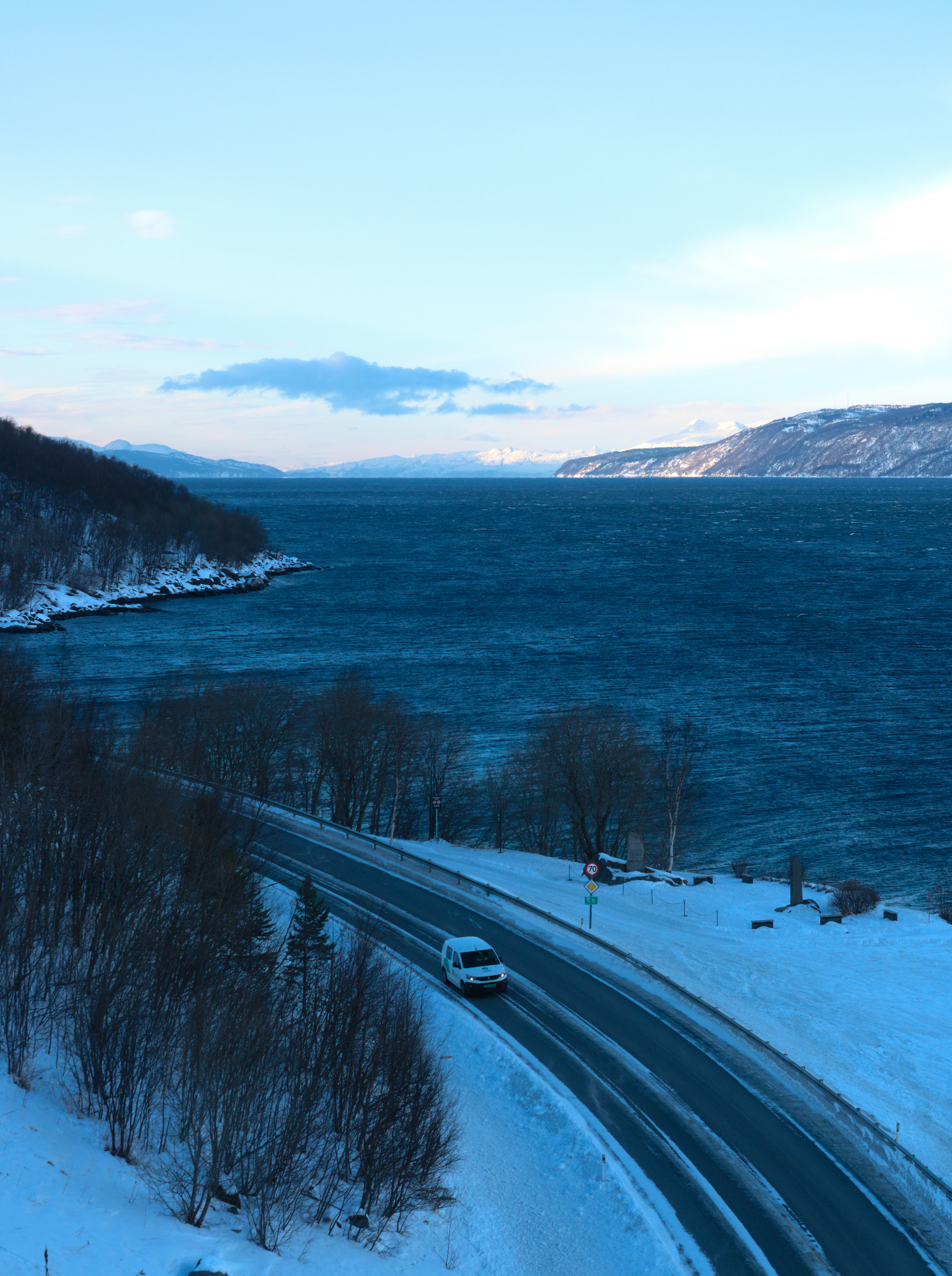 Snowbound Coastline: A Winding Road Beside a Frigid Sea