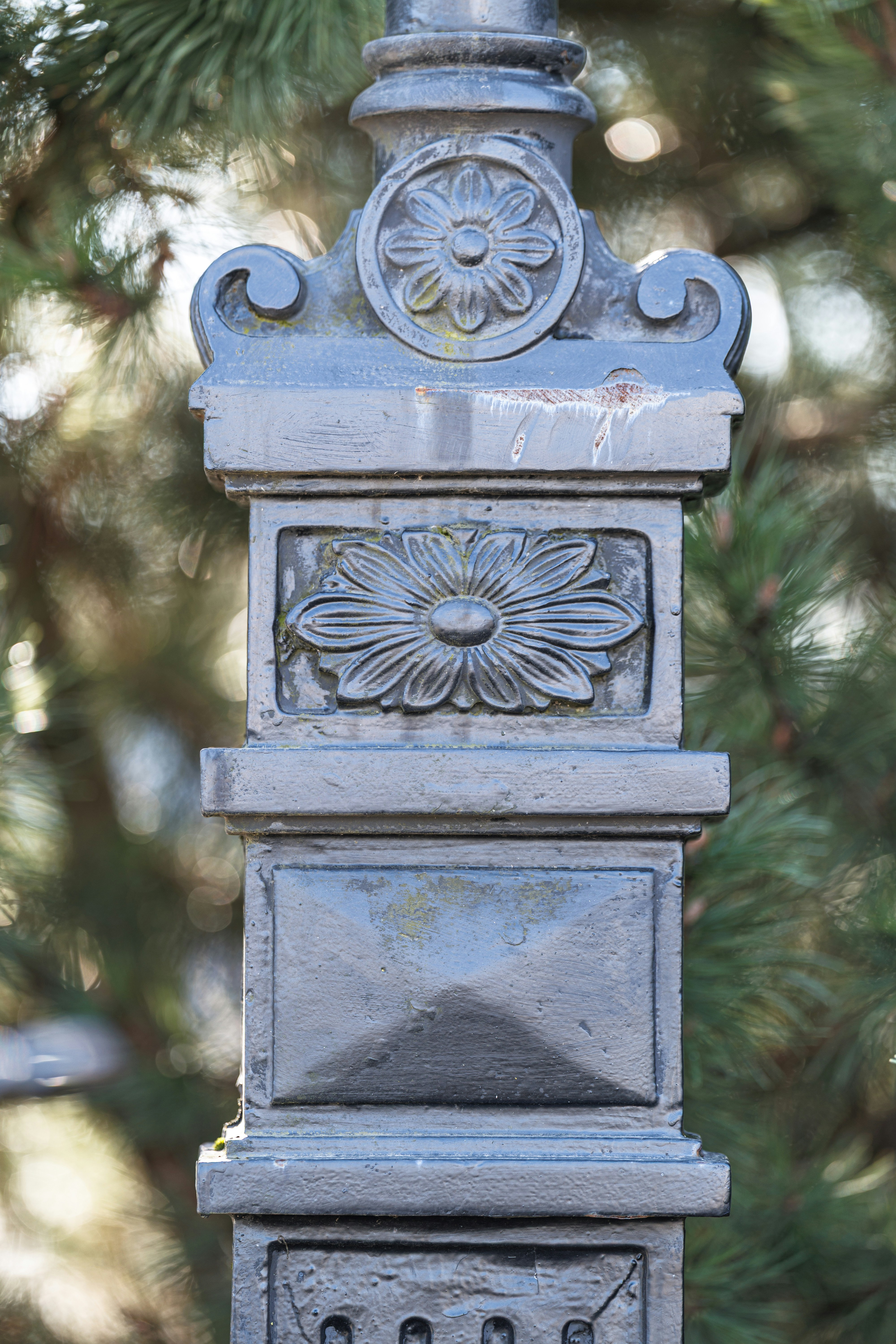 Ornate stone lantern rises from shadowed pines