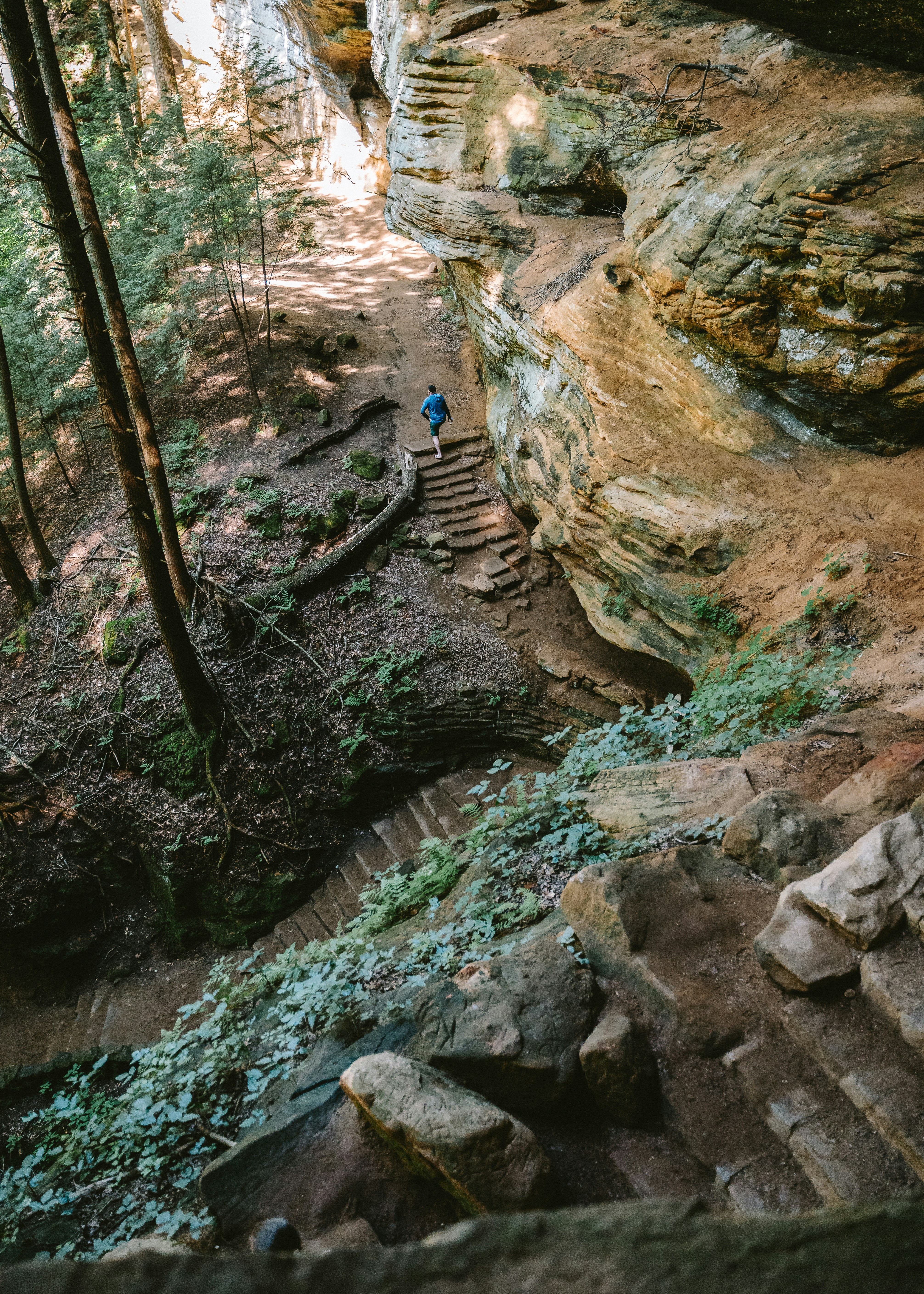 A Narrow Ascent: Wanderer Tracing a Rugged Canyon Staircase
