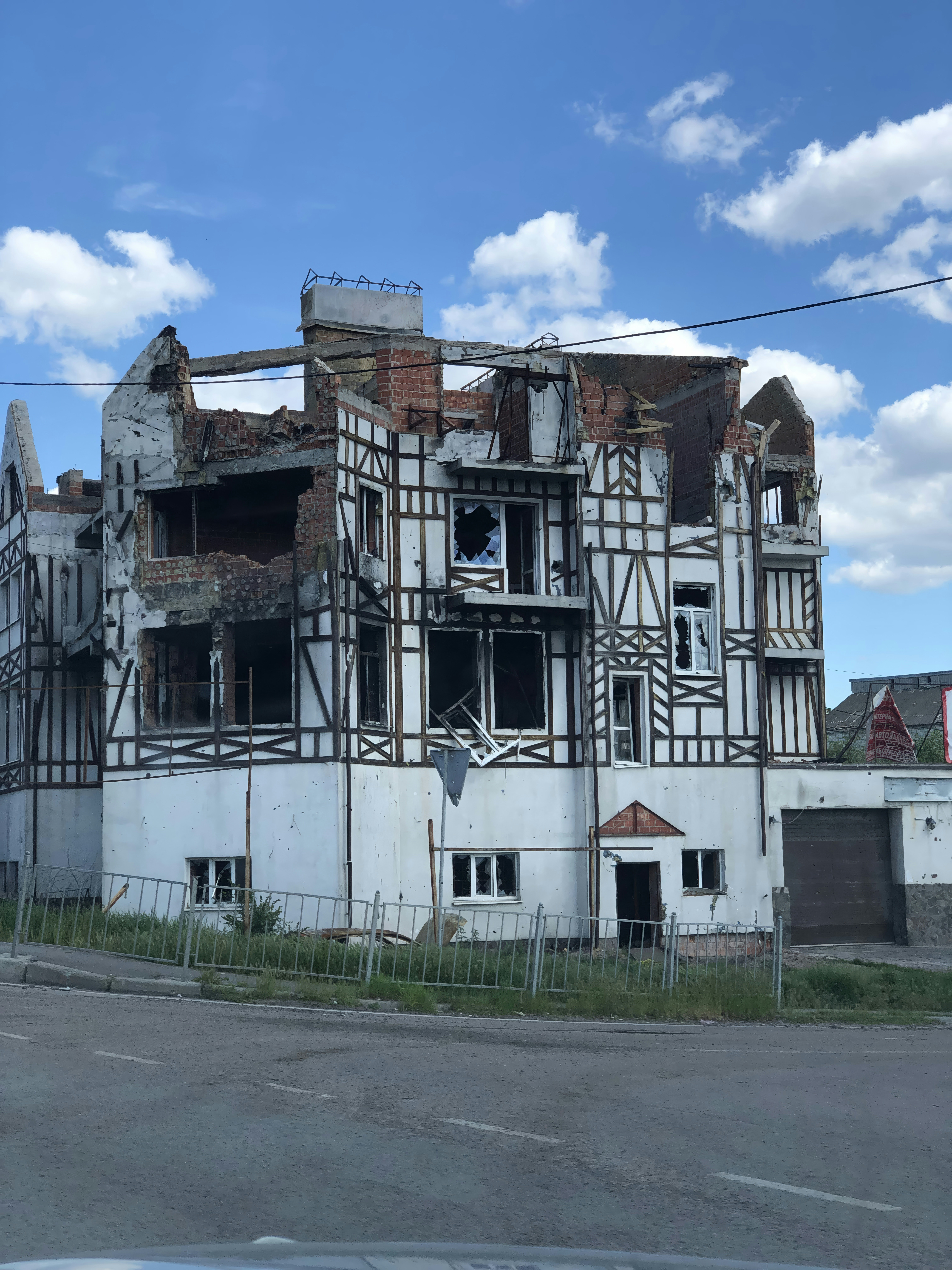 Crumbling Tudor Facade: A Dilapidated Villa Rising from a Quiet Street