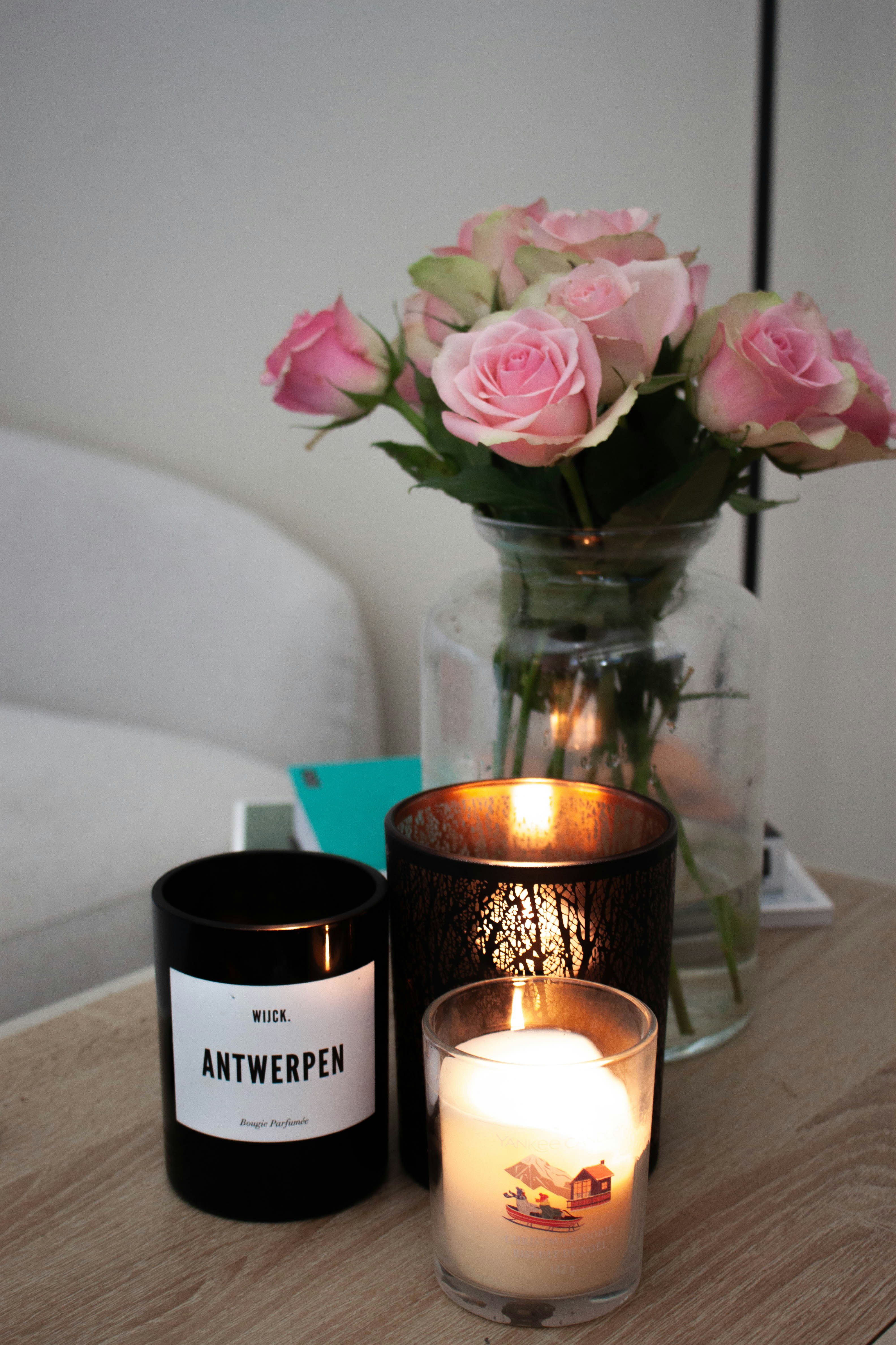 Pink Rose Bouquet with Candlelit Glow on a Wooden Table